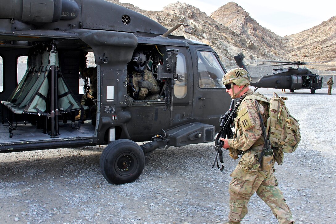 U.S. Army Cpl. Joseph Ritchey prepares to board a UH-60 Black Hawk ...