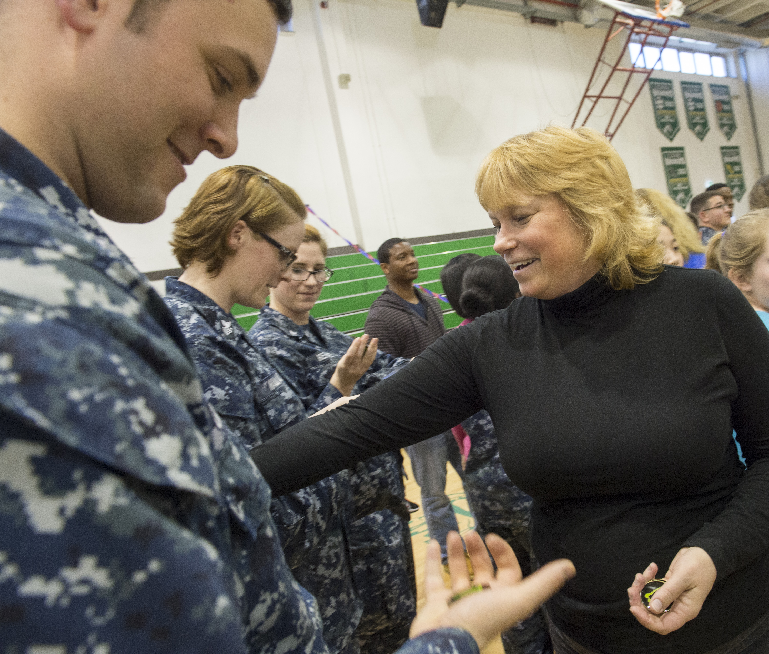 Mary Winnefeld, wife of U.S. Navy Adm. James A. Winnefeld Jr., greets ...