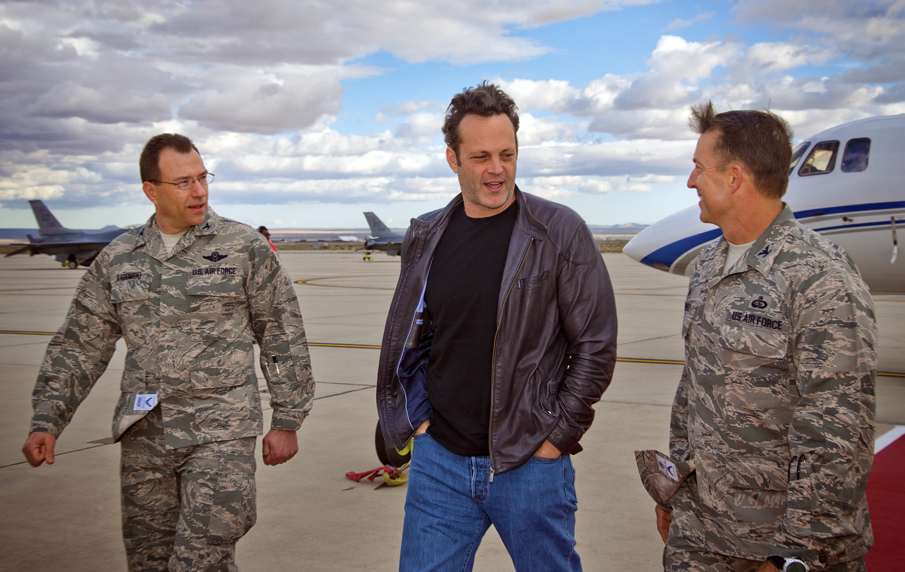 Actor and USO tour veteran Vince Vaughn, center, is greeted by Air ...