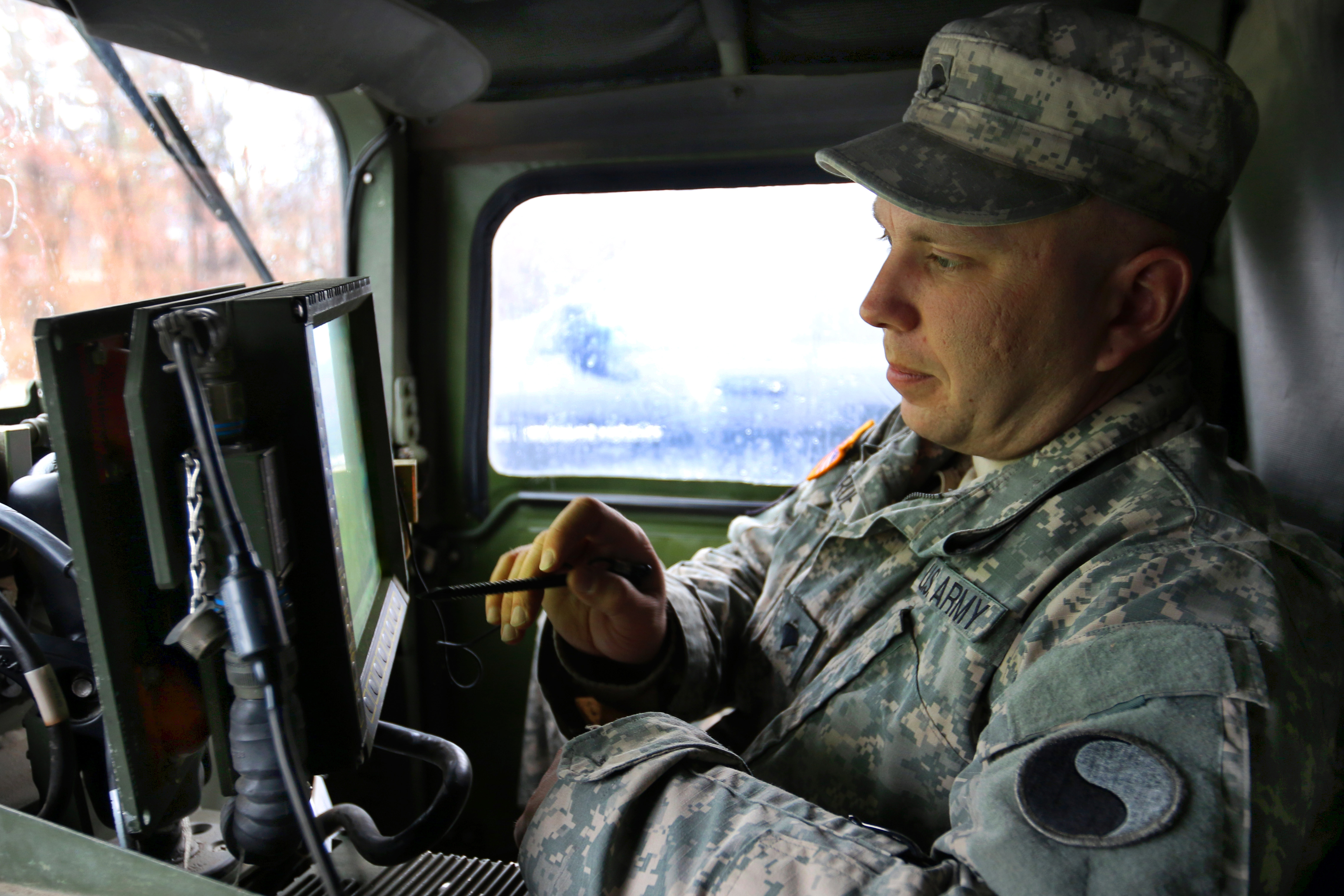 Army Spc. Michael Monroe prepares communications equipment inside a ...