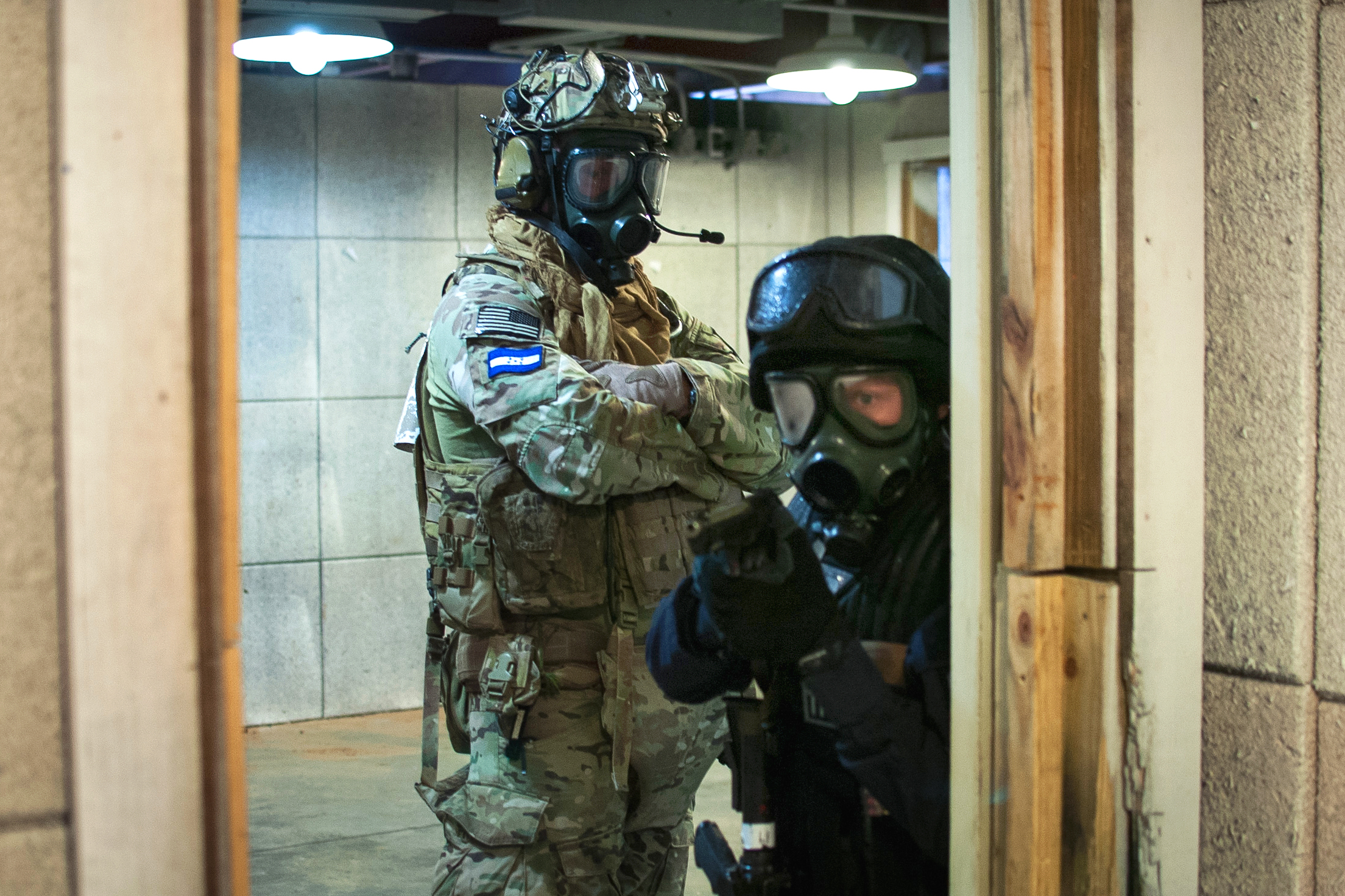 An Army Green Beret, left, observes the performance of a Honduran ...
