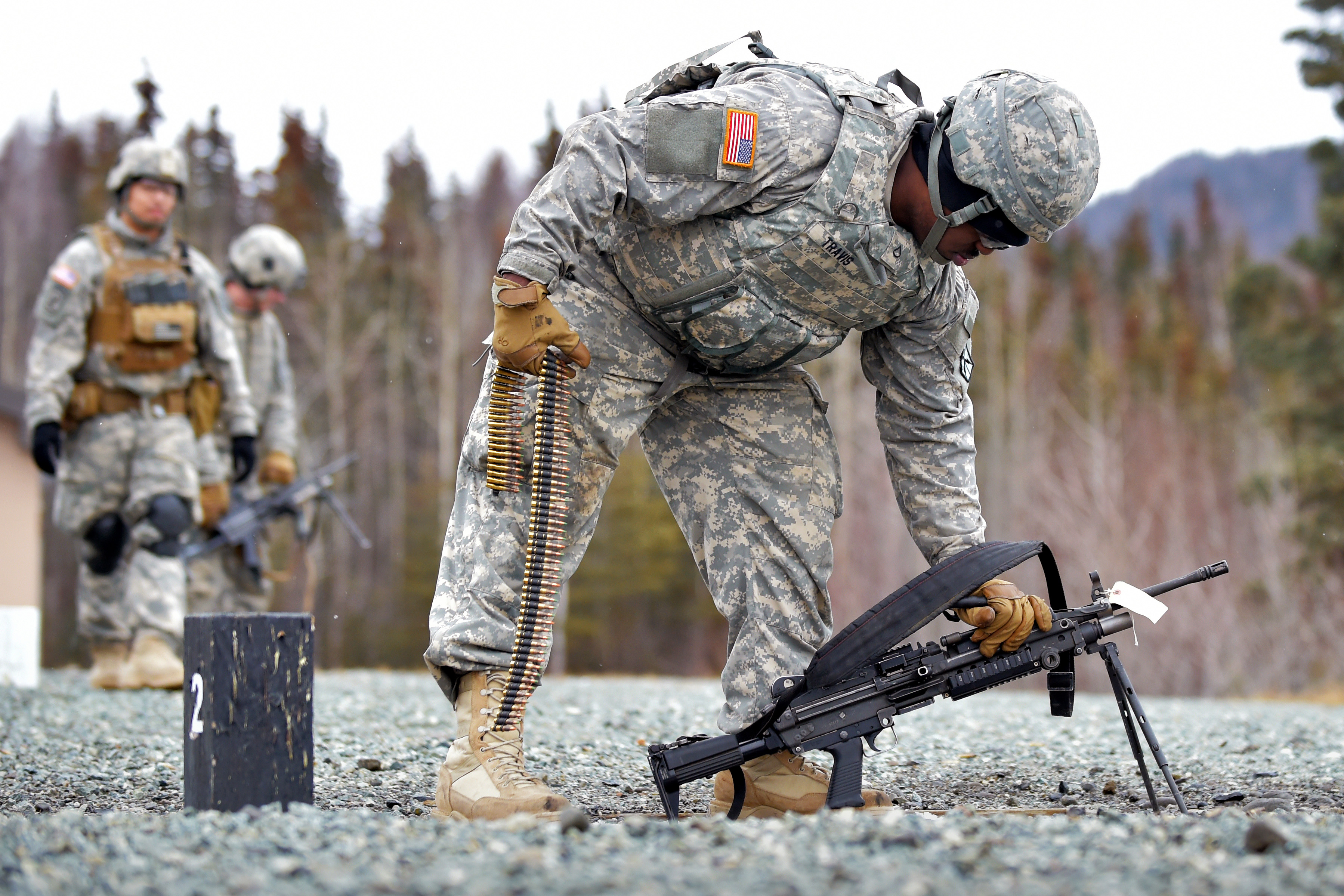 Spc. James Travis awaits the order to load his M249 Squad Automatic ...