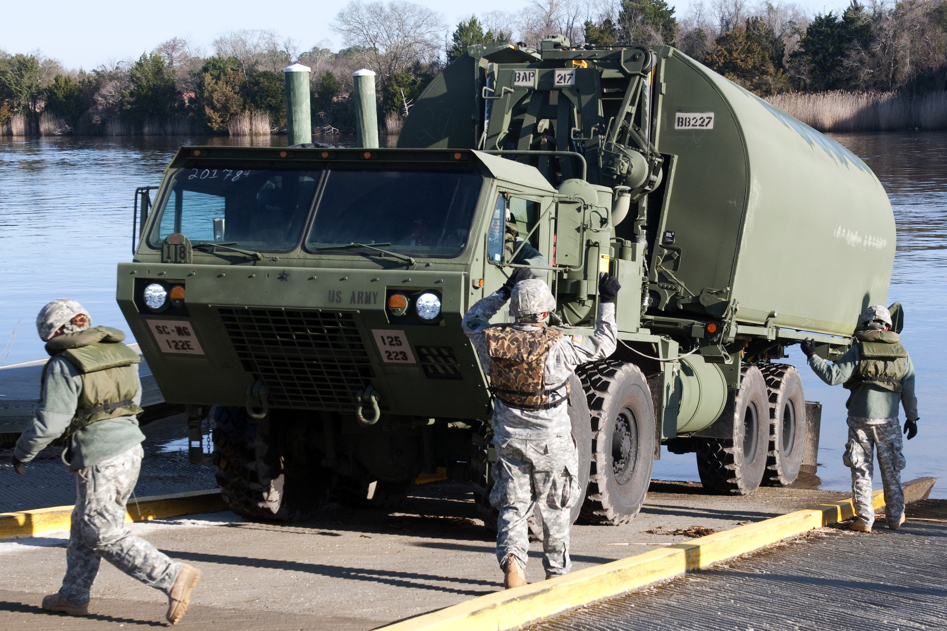 Soldiers use a common bridge transporter to launch an improved ribbon ...