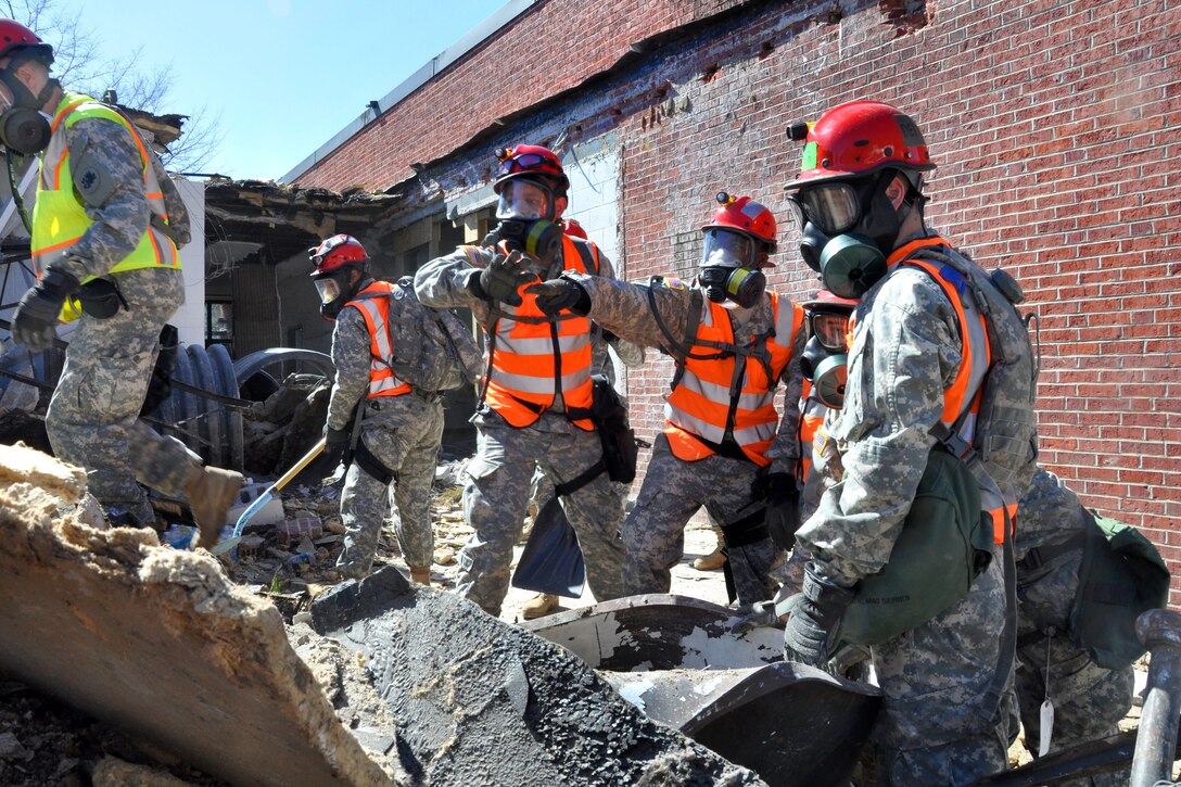 Army Staff Sgt. Gary Johnson, center right, directs soldiers during the ...