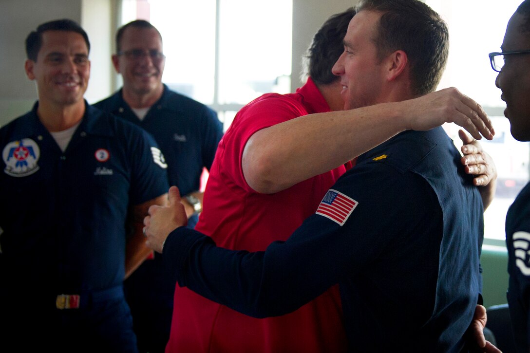 Air Force Maj. Joshua Boudreaux, right, embraces a patient during a ...