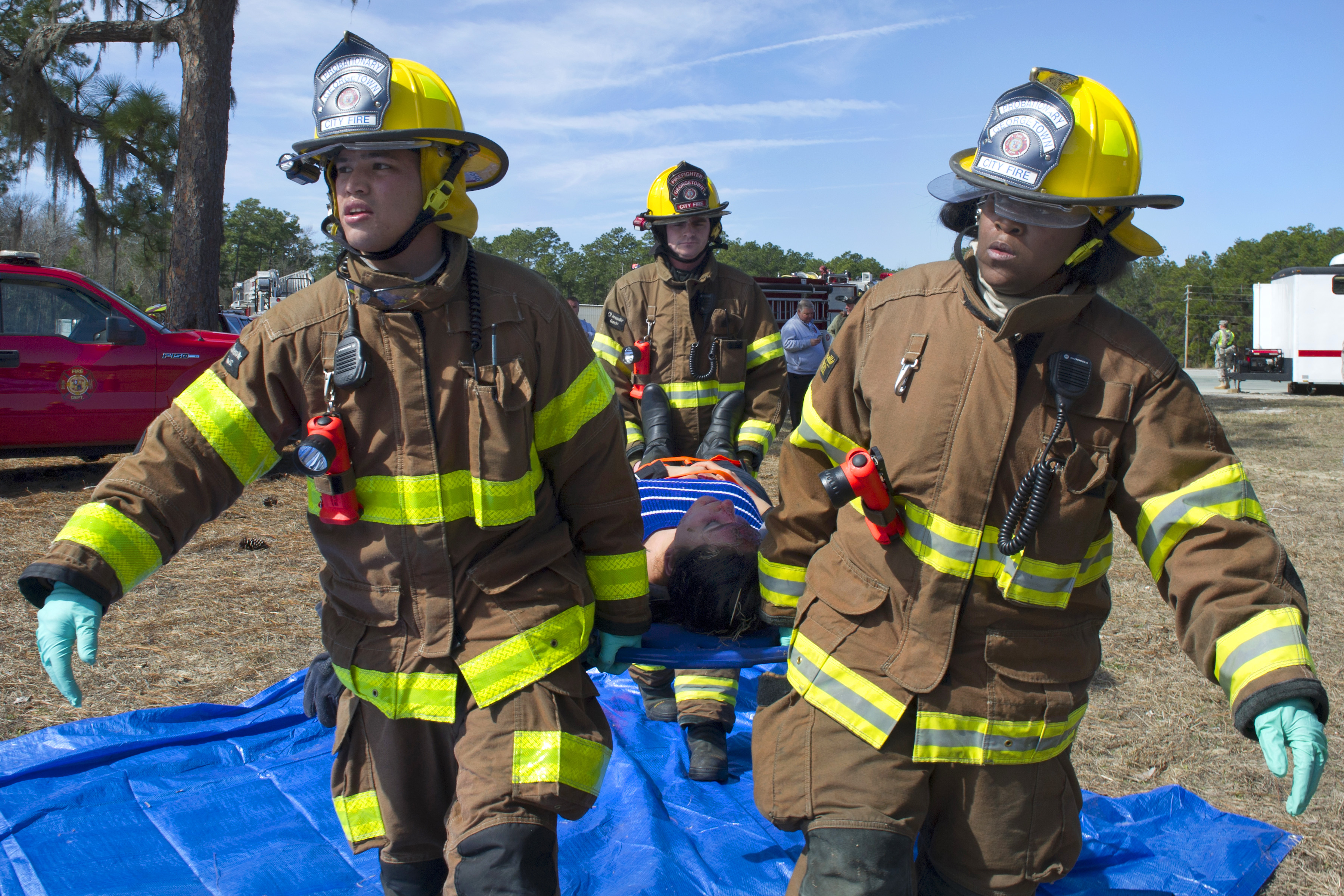 City firefighters carry a simulated victim to a triage tent during ...
