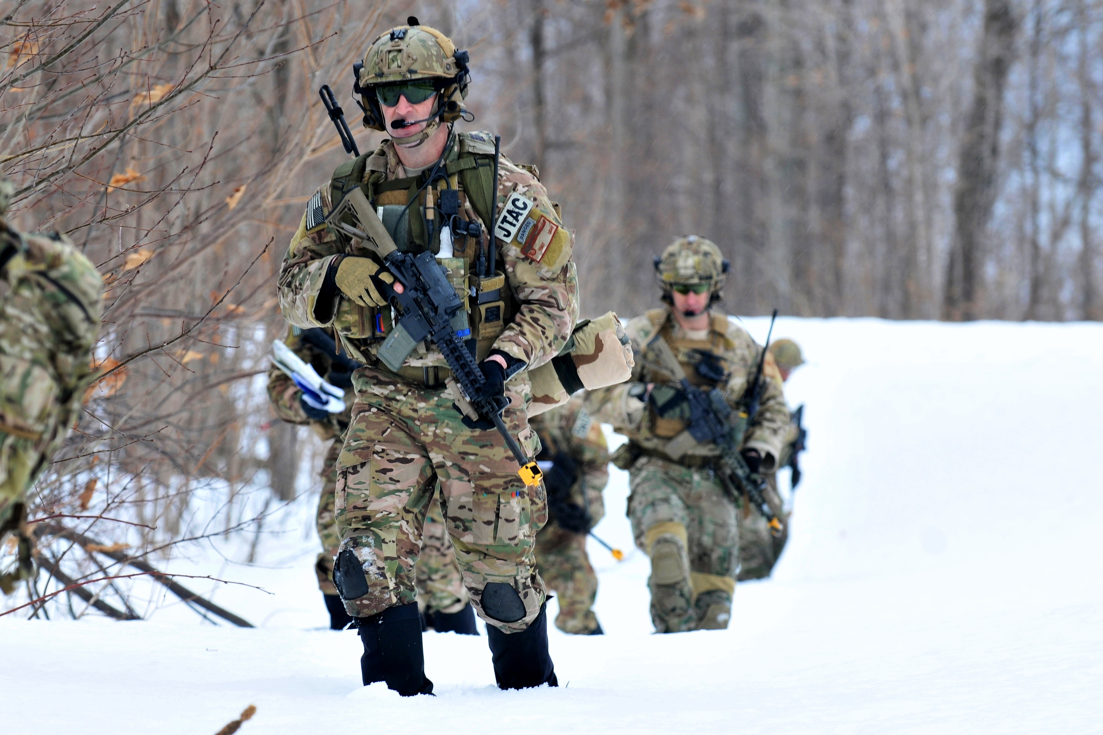 Air Force Tech Sgt. Jason Farrand, foreground, moves toward an ...