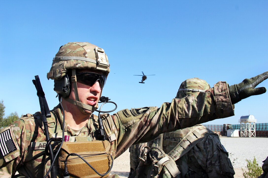 U.S. Army 1st Lt. Jack Abate provides direction as a UH-60 Black Hawk ...