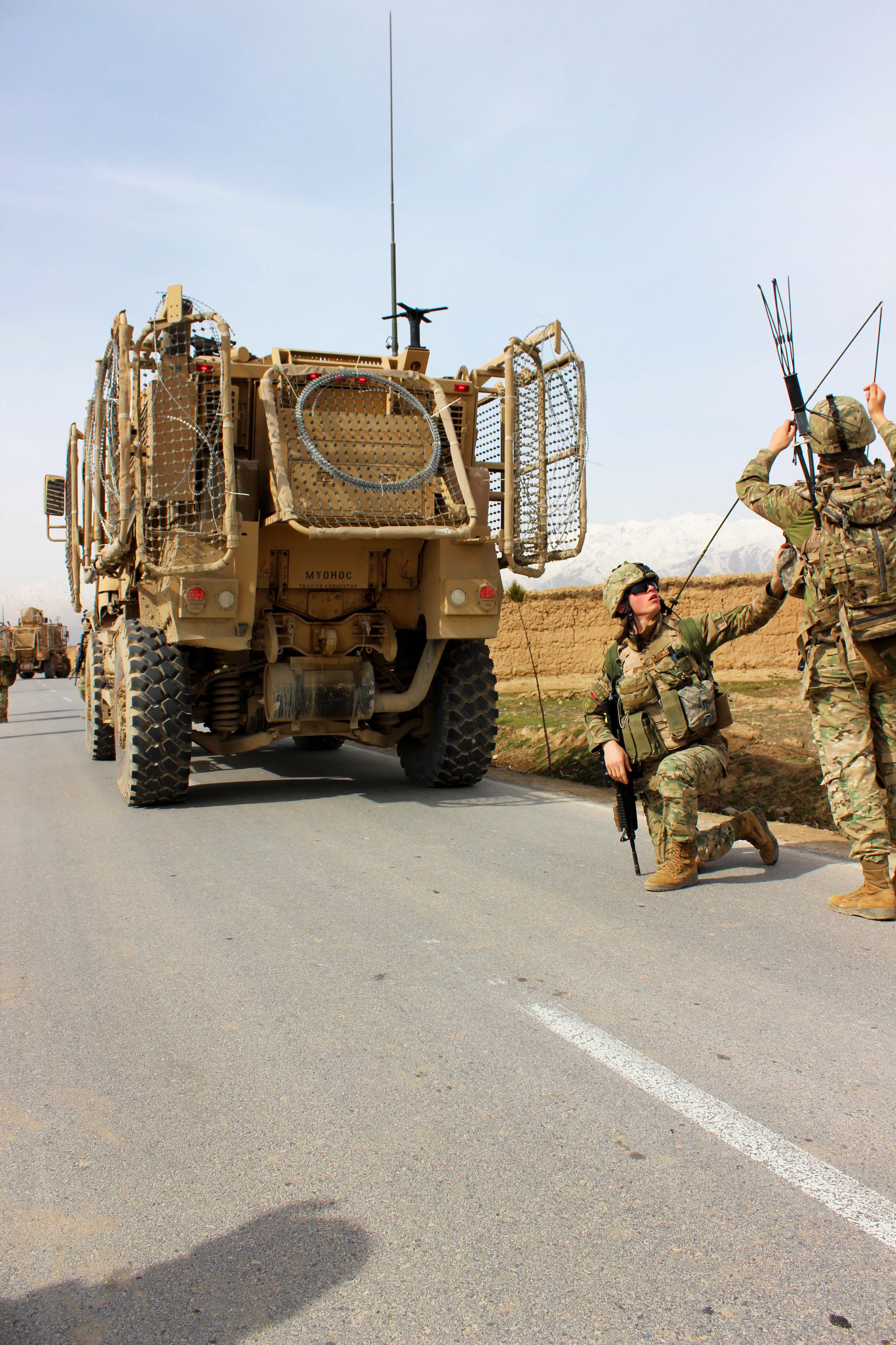 Georgian soldiers prepare their equipment before moving out on a patrol ...
