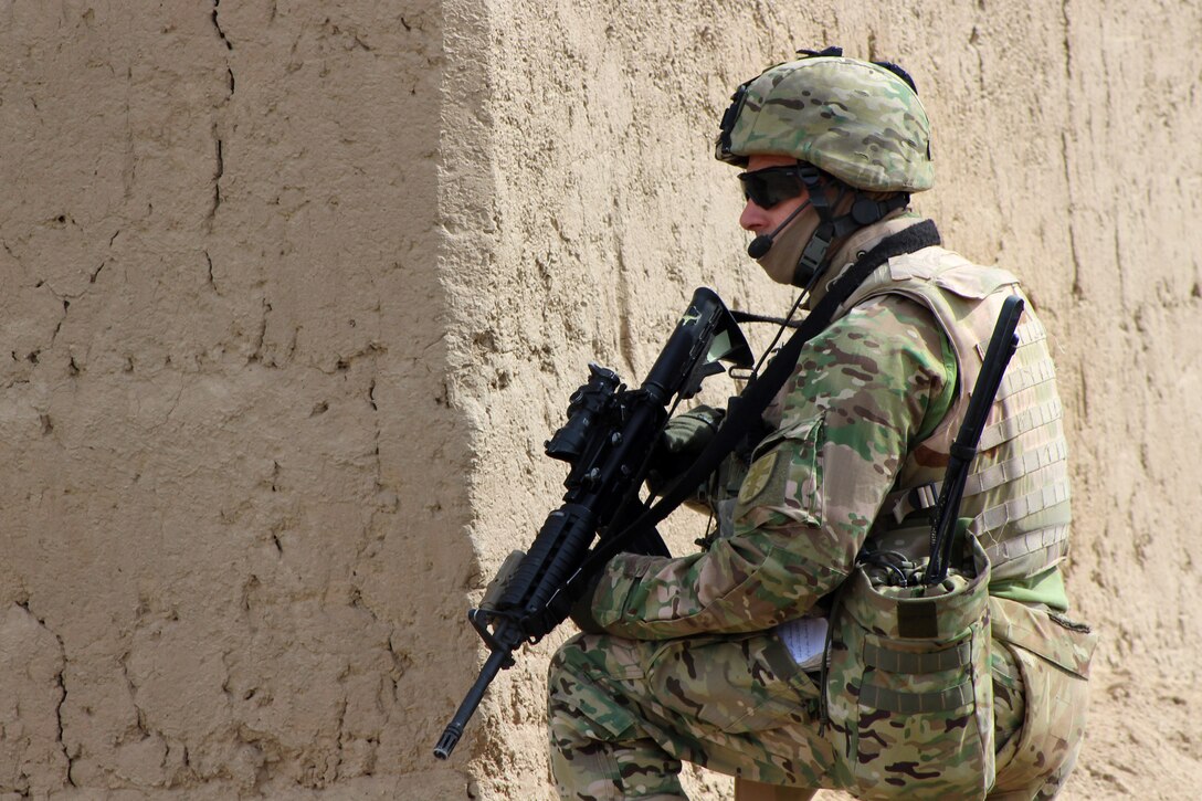 A Georgian soldier takes a knee while providing security during a ...