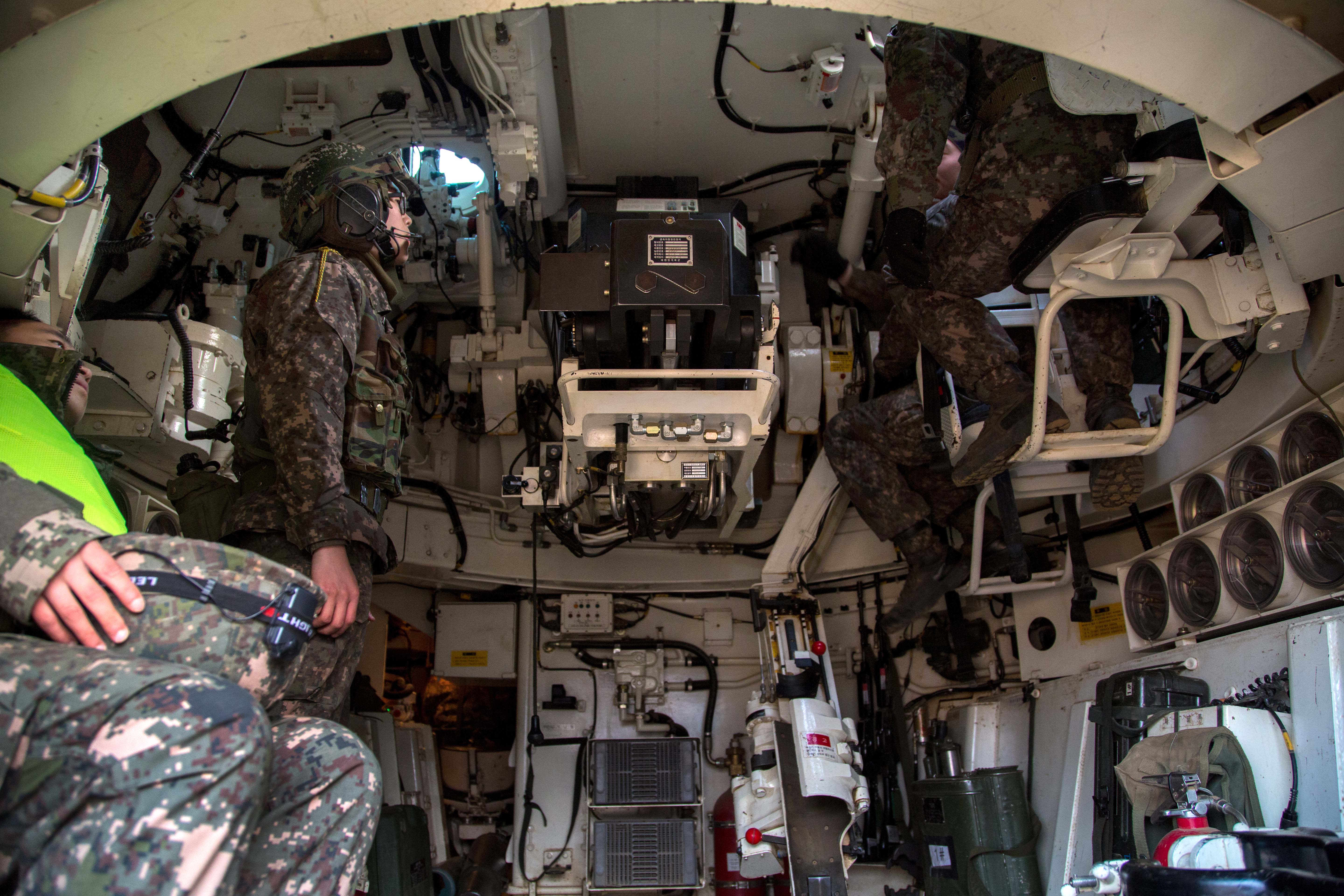 South Korean and U.S. soldiers conduct pre-combat checks on a Korean ...