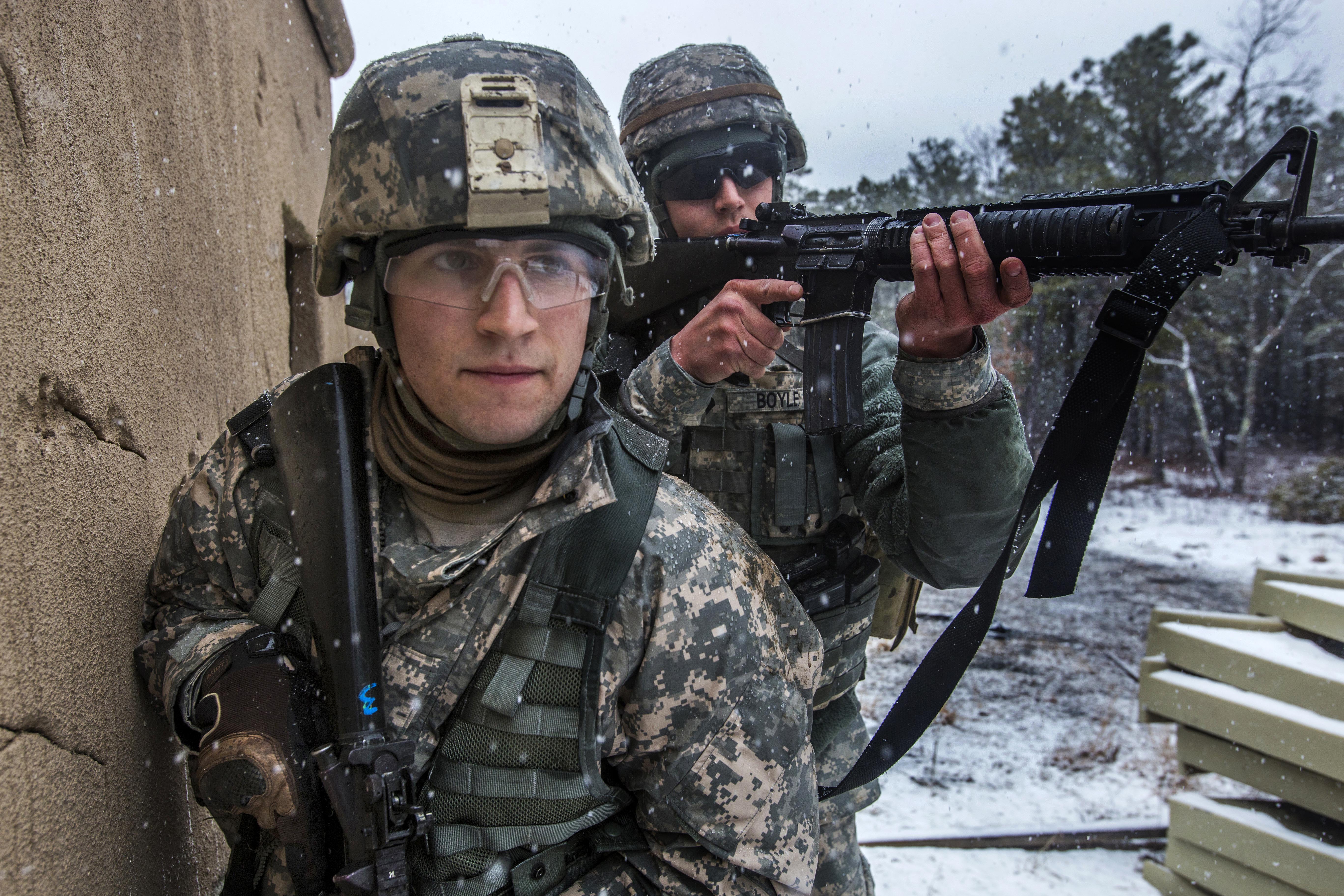 Army Spc. Brendan P. Boyle, back, provides cover while Army Spc. Tyler ...