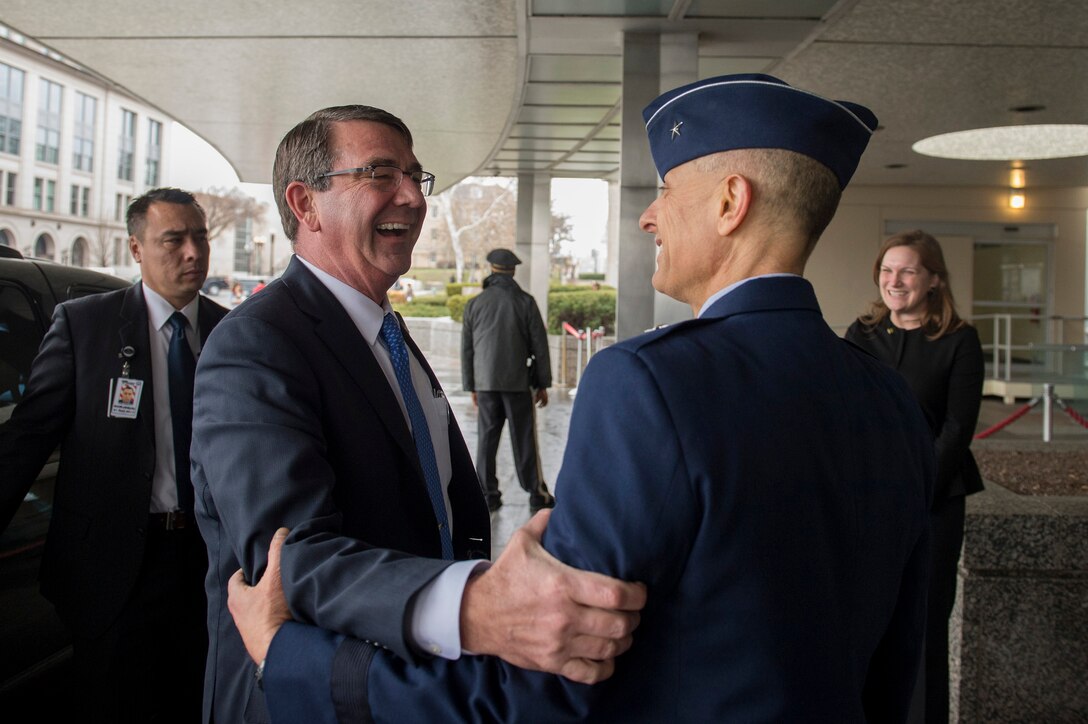 Defense Secretary Ash Carter, left, shakes hands with Air Force Brig ...