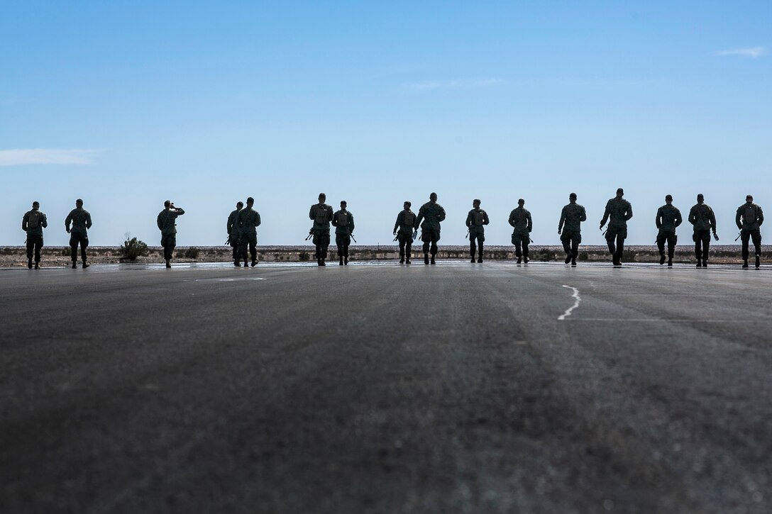 Marines attending the infantry officers course clear the flight line ...