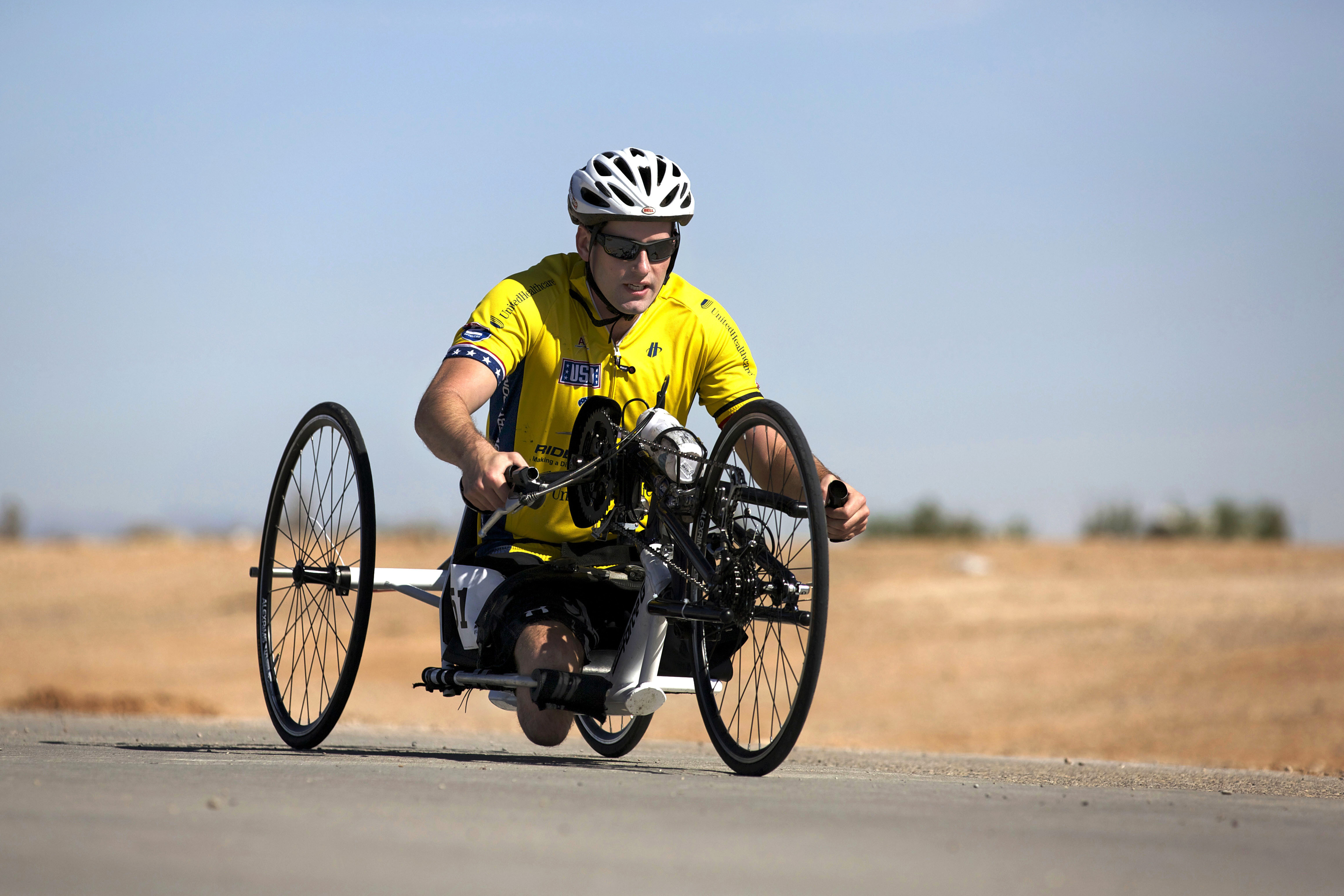 Army Sgt. Stefan Leroy moves his hand cycle down a straightaway during ...