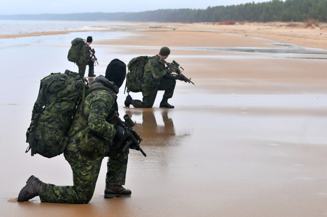 U.S. soldiers participate in a water infiltration exercise with Latvian ...