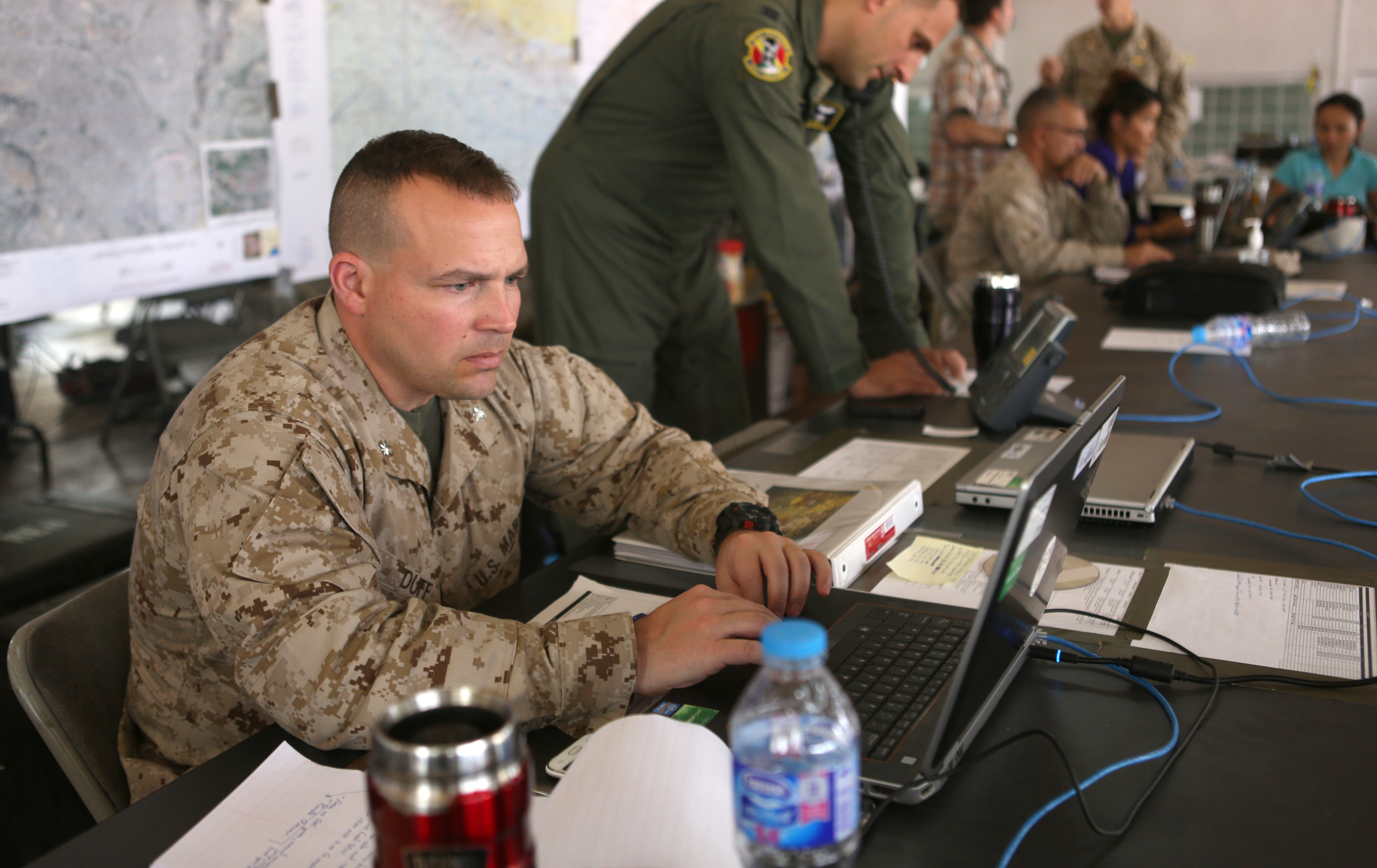 U.S. Marine Corps Lt. Col. Jared Duff works in the command center for ...