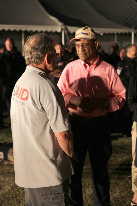 Alfonso Lenhardt, USAID acting administrator, talks with a fellow USAID ...