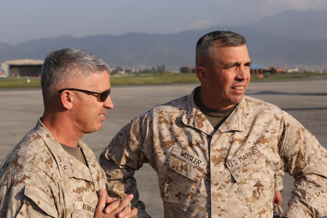 Marine Brig. Gen. Paul Kennedy talks with Lt. Gen. John Wissler at the ...