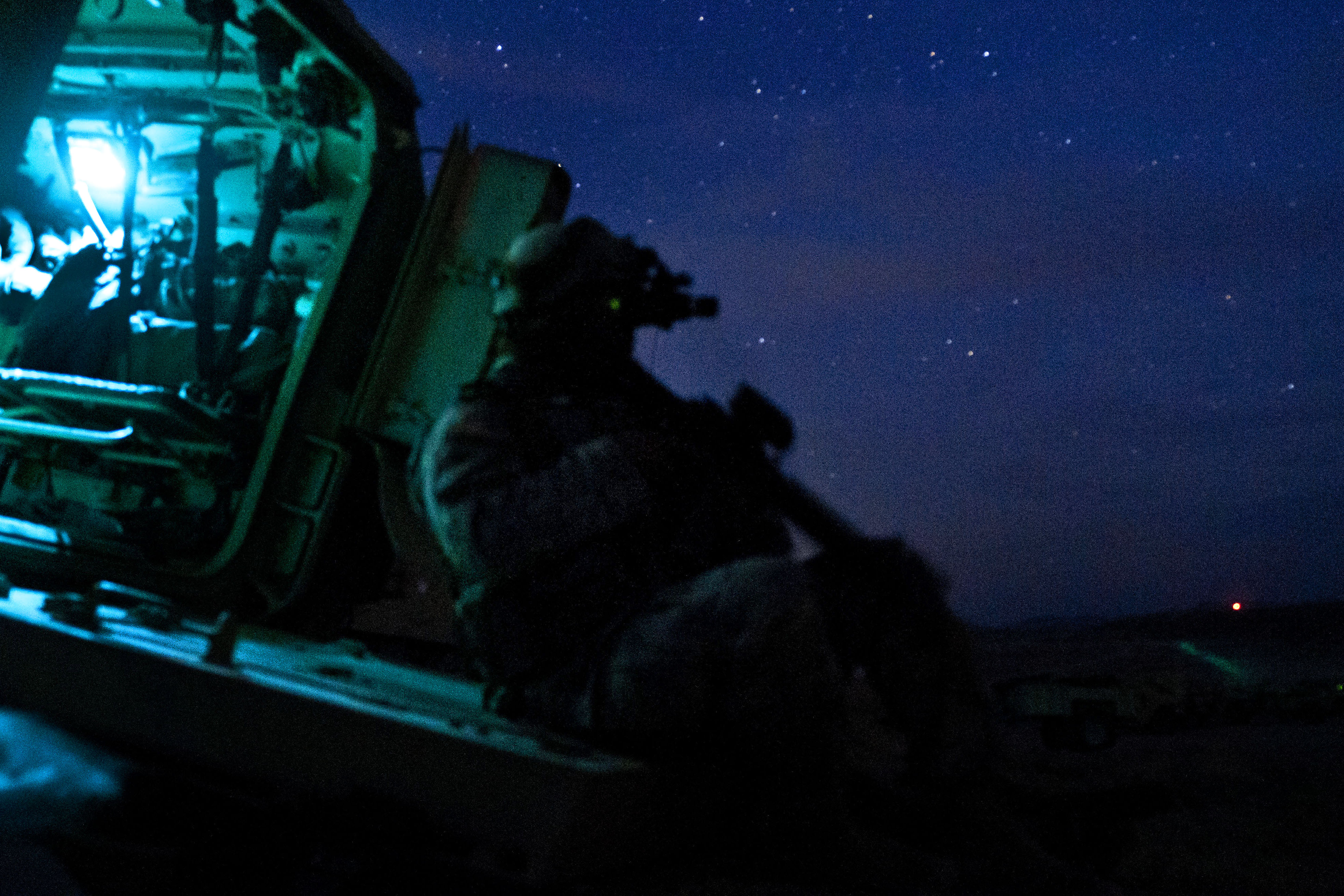 A soldier provides security from the back of a tactical vehicle while ...