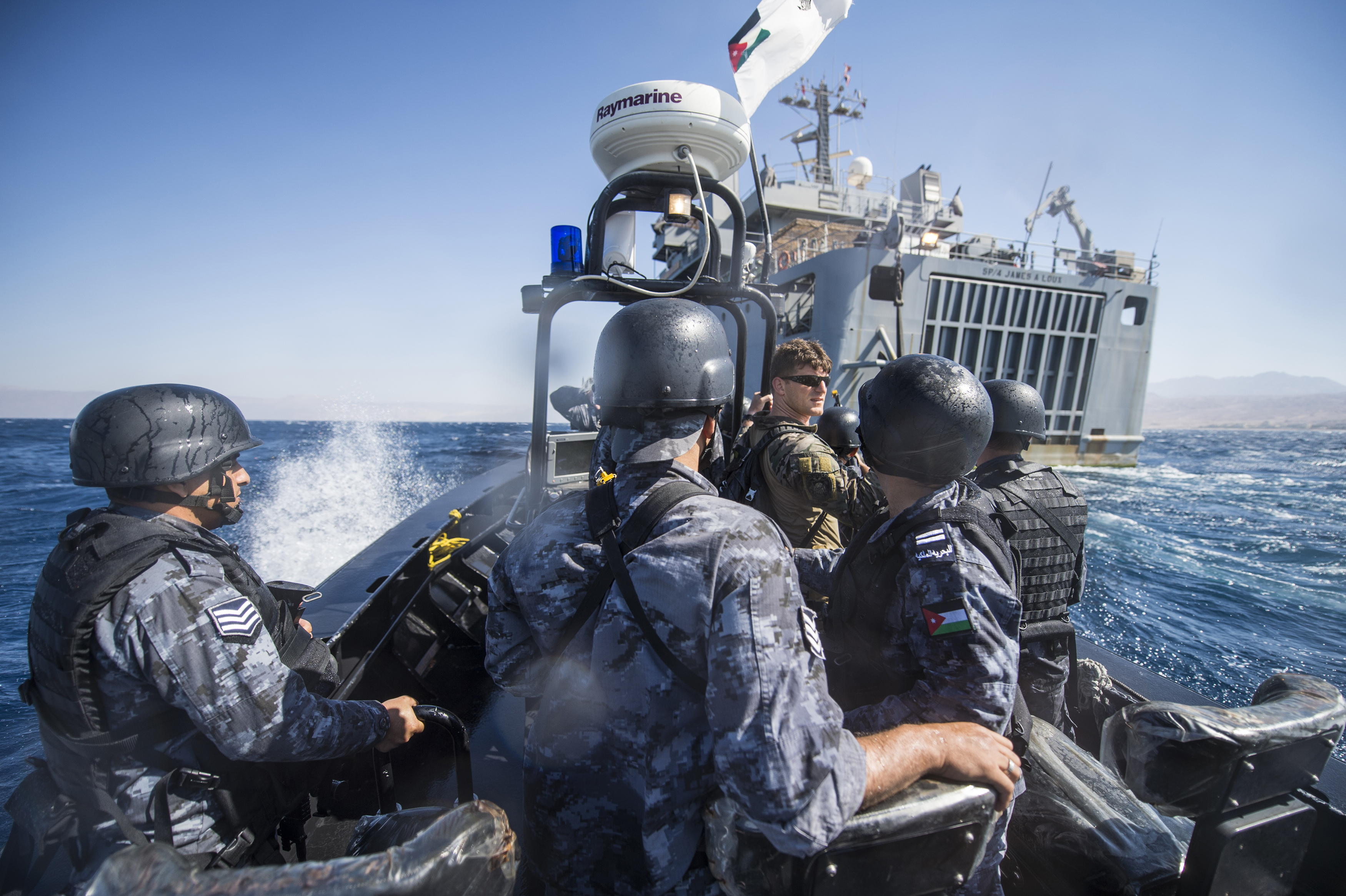 Jordanian military personnel and U.S. Coast Guardsmen prepare to board ...