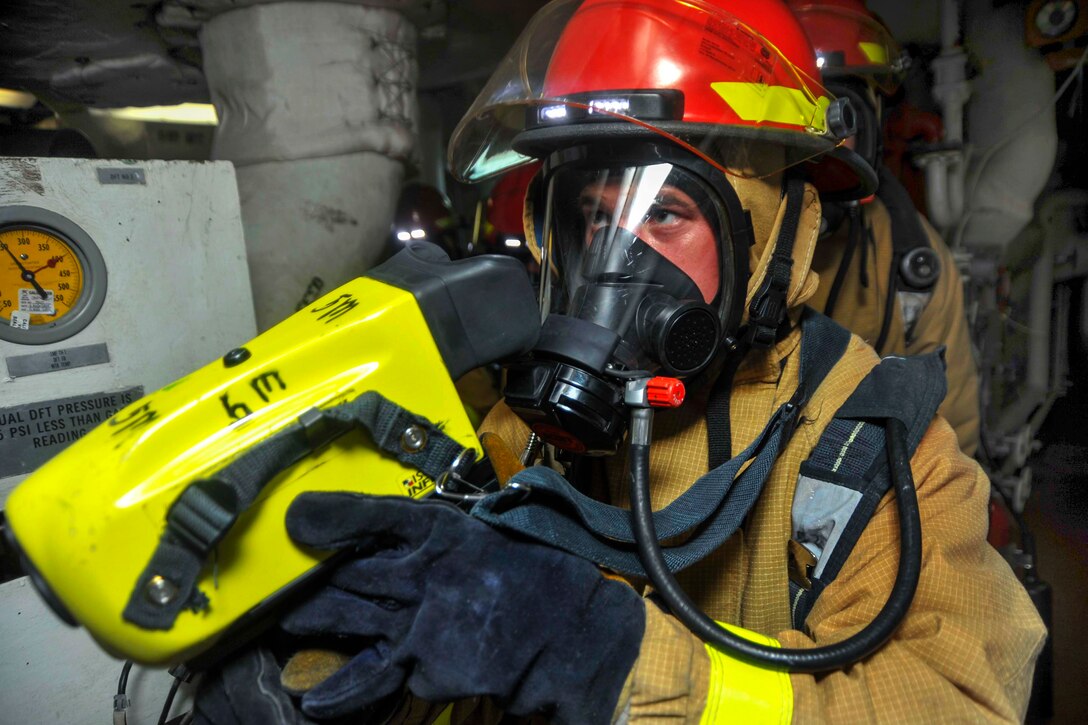 U.S. Navy Petty Officer 2nd Class Christian Karsemeyer uses a navy ...