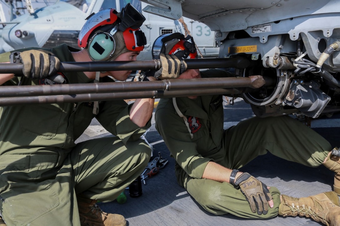 US Marines make sure helicopter's weapons are ready to fire at sea