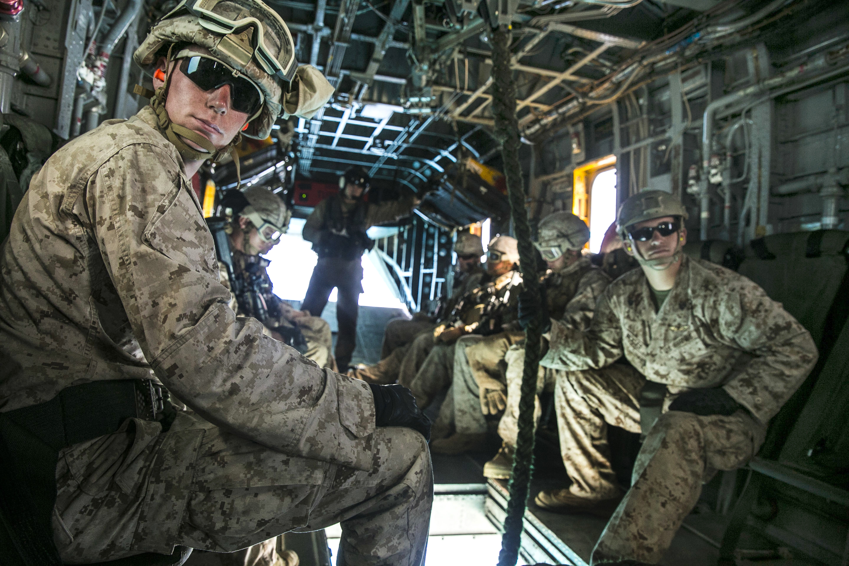 Marines prepare to fast-rope from a CH-53E Super Stallion helicopter on ...