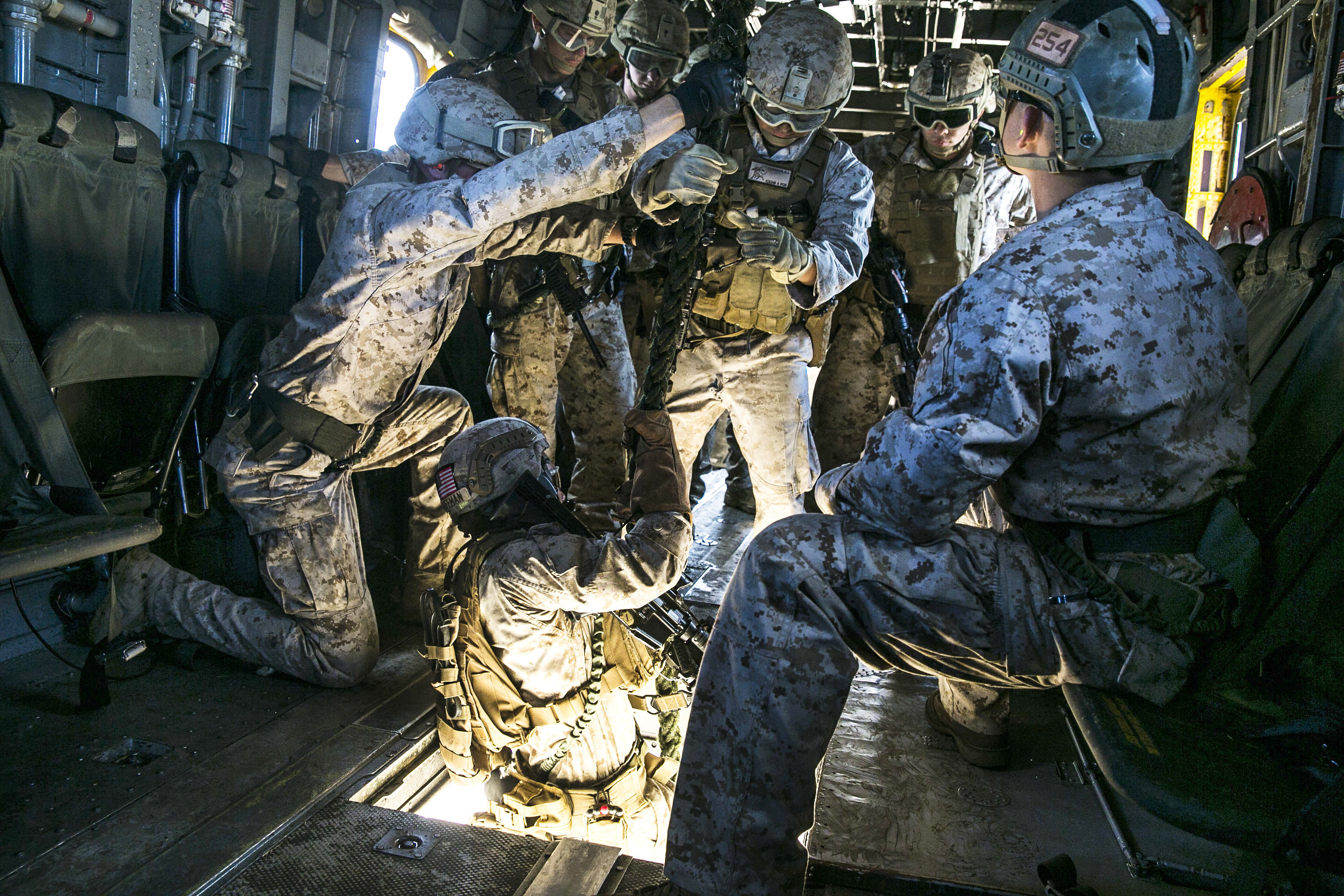 Marines fast-rope from a CH-53E Super Stallion helicopter on Marine ...
