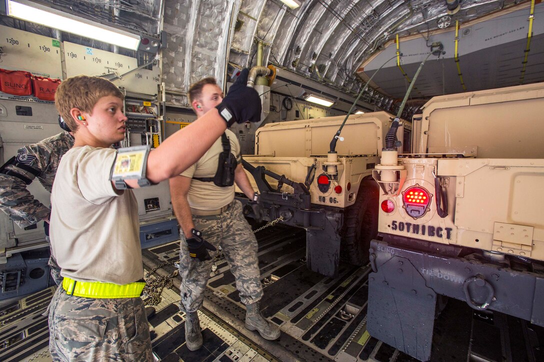 Air Force Airman 1st Class Lacy Thompson, foreground, gives a thumbs-up ...