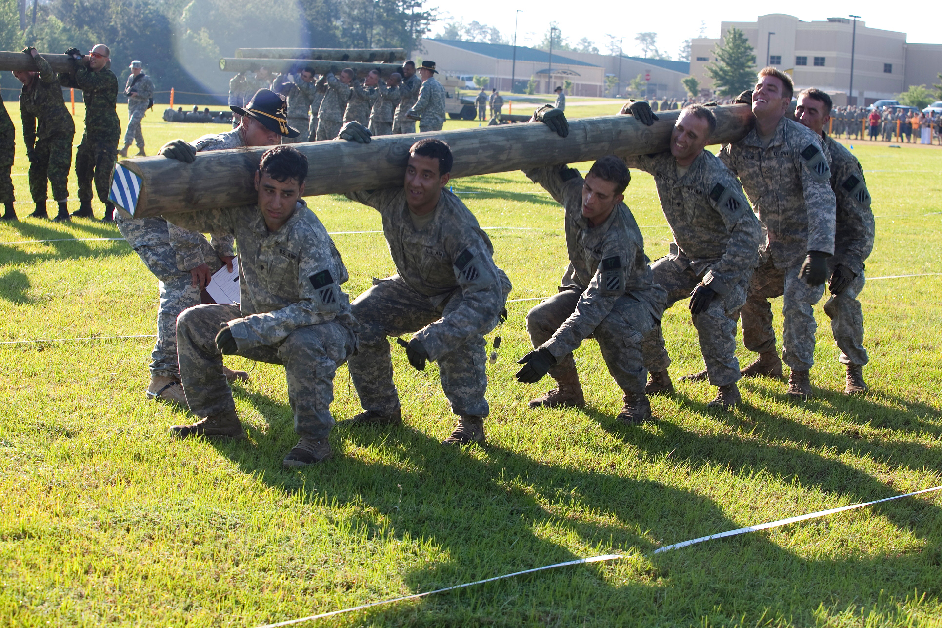 U.S. soldiers do squats while holding a log during the Gainey Cup ...