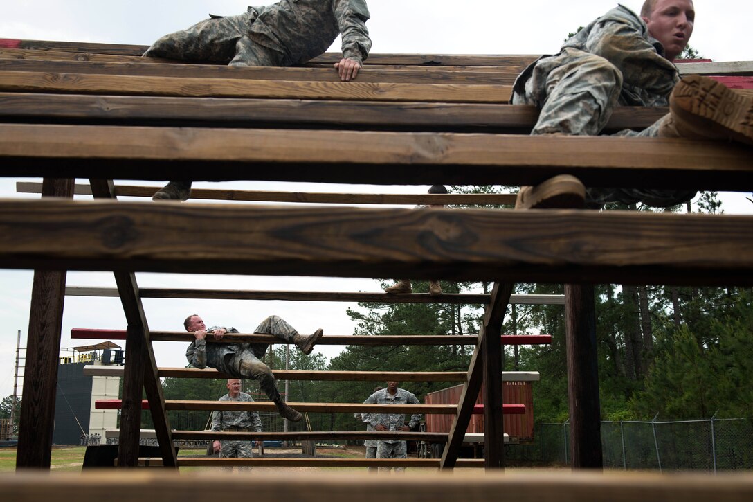 Paratroopers weave through the “Over/Under” part of the team assault ...