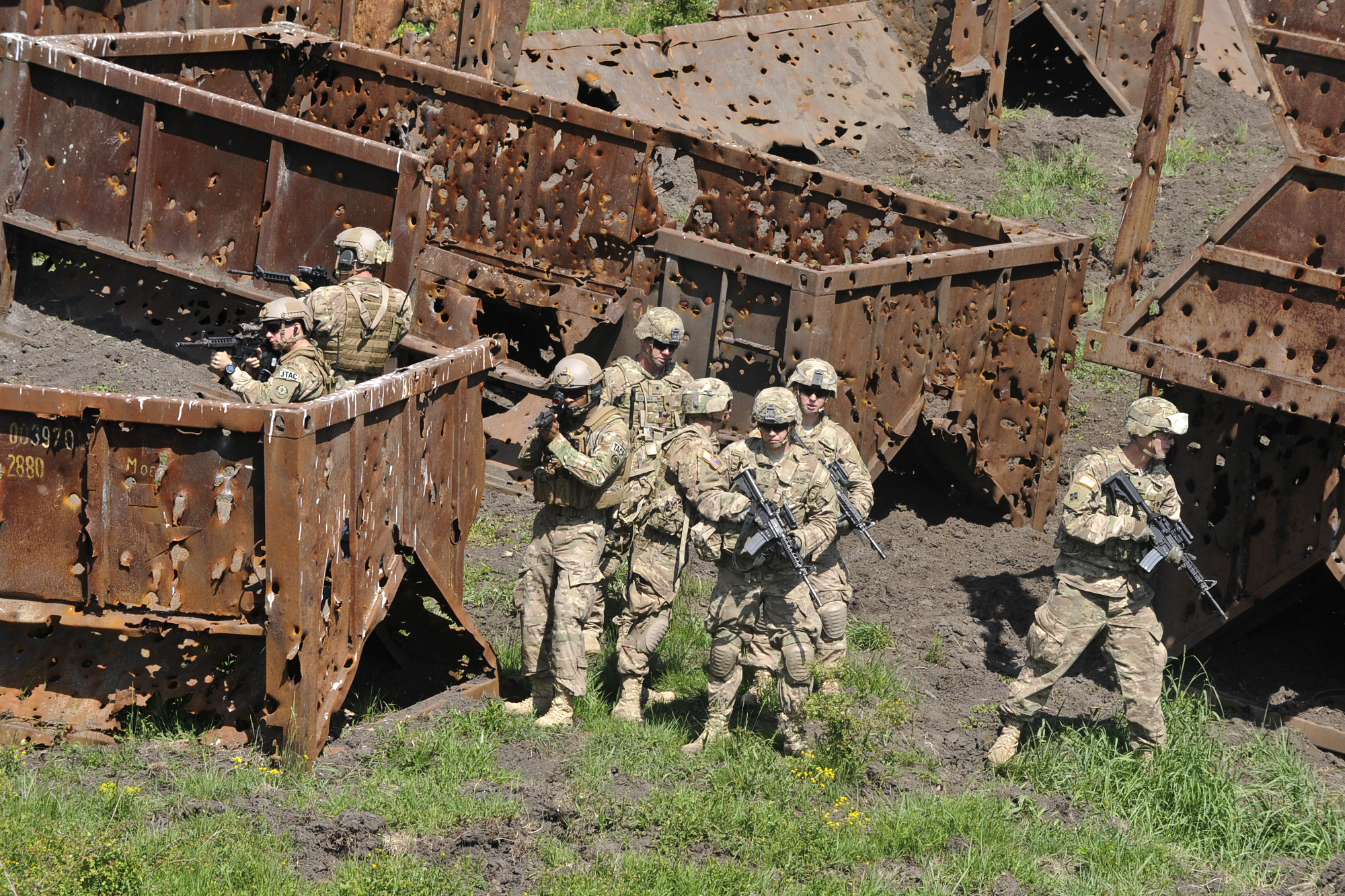 U.S. soldiers and airmen set up a security perimeter in preparation for ...