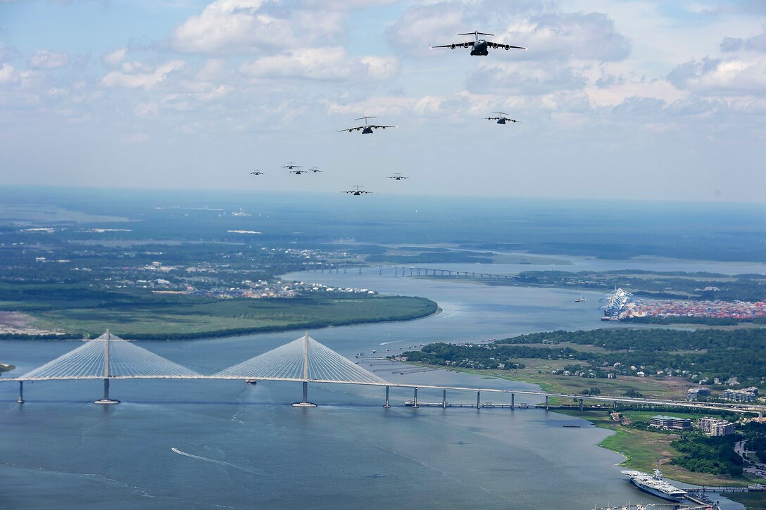 A formation of U.S. Air Force C-17 Globemaster IIIs fly over the Arthur ...