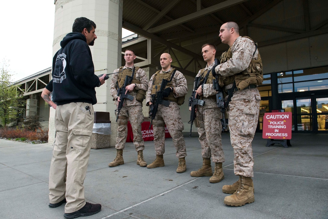 John Knipe, left, a high risk response instructor, briefs U.S. Marines ...