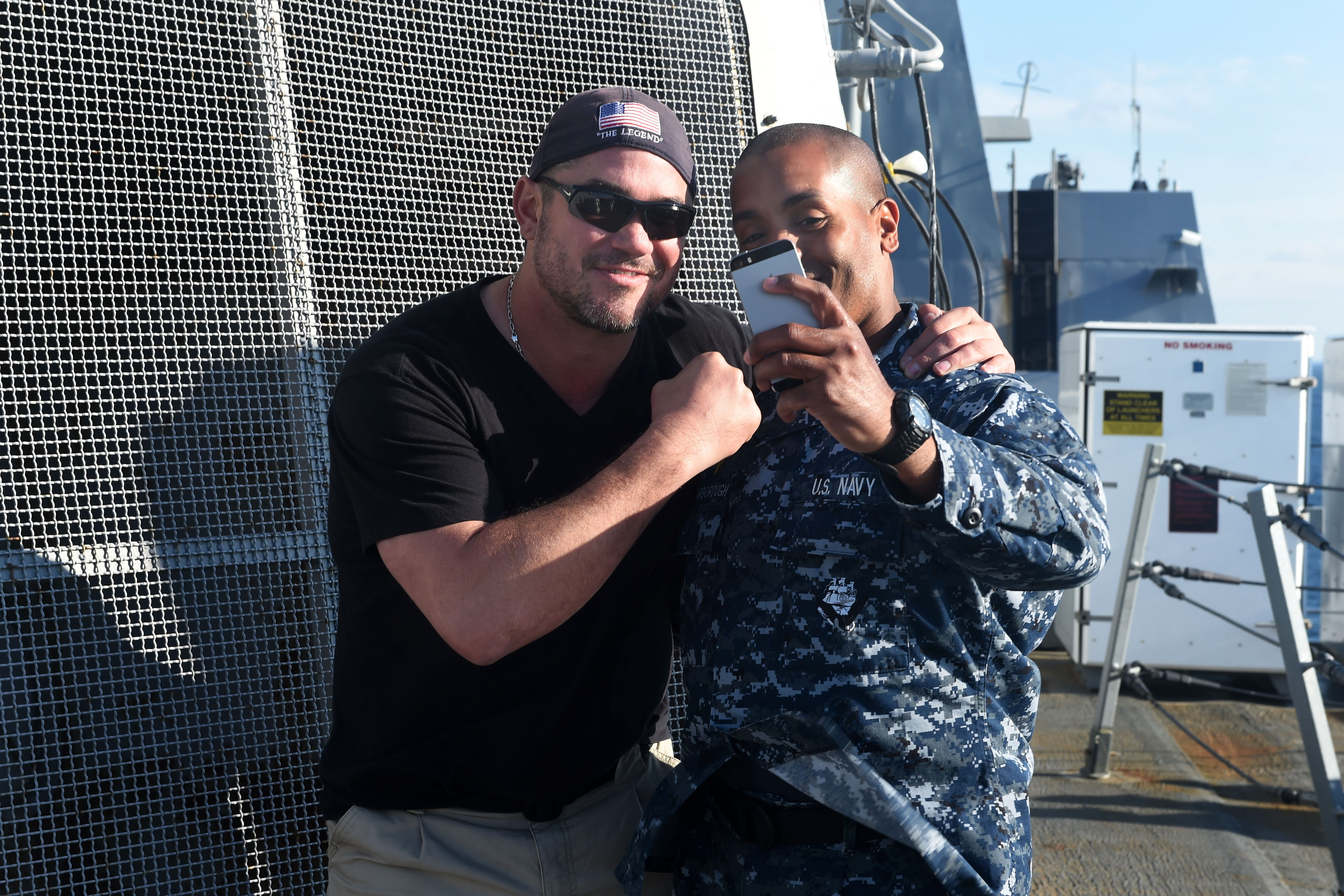 Navy Master-at-Arms Seaman Nicholas Scarborough, right, takes a selfie ...