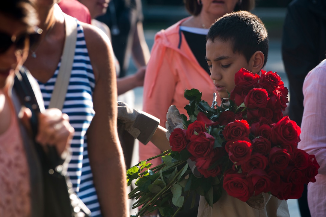 Dylan Finch, 10, with Boy Scout Troop 976 from Vienna, Va., hands roses ...