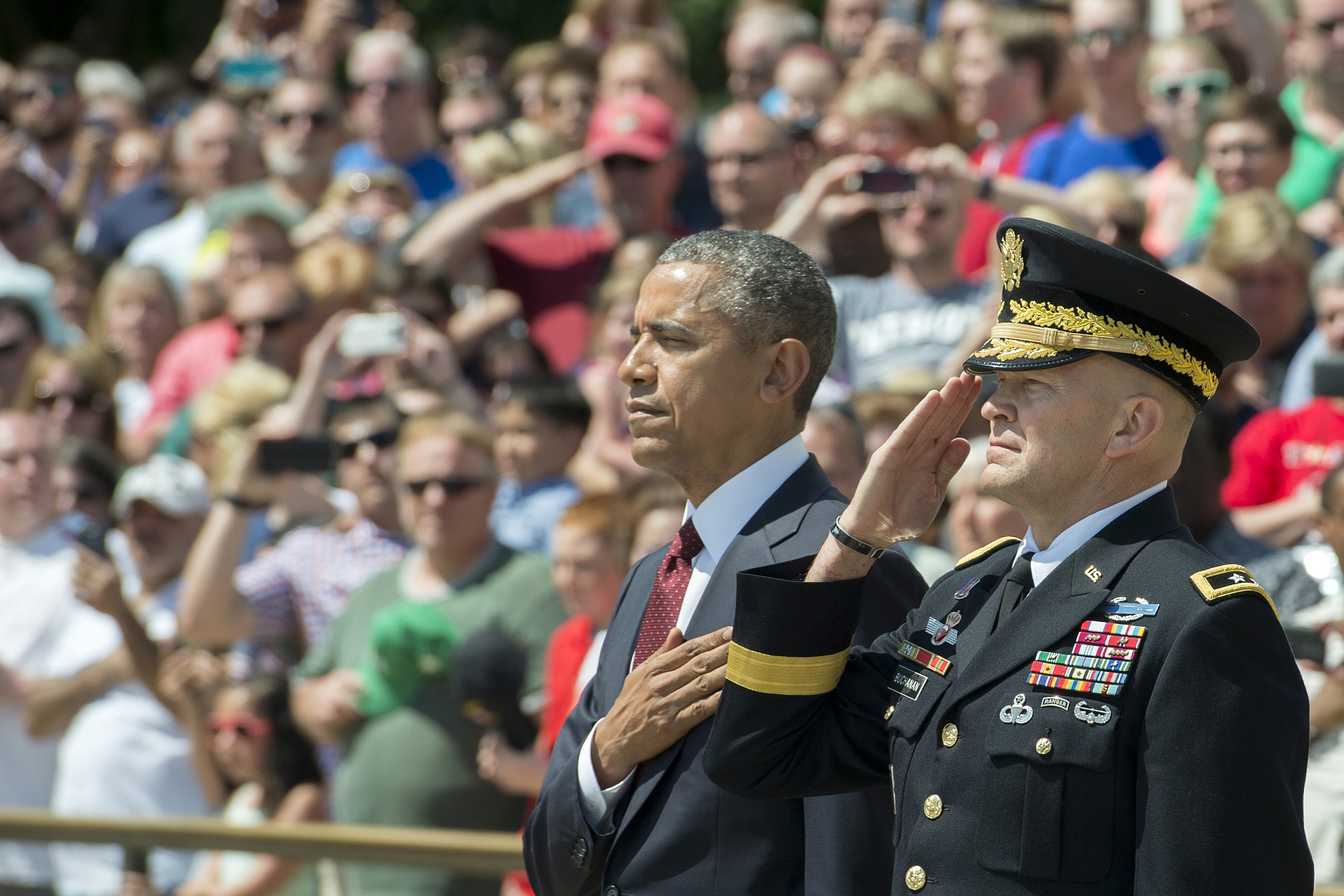 President Barack Obama places his hand over his heart before laying a ...