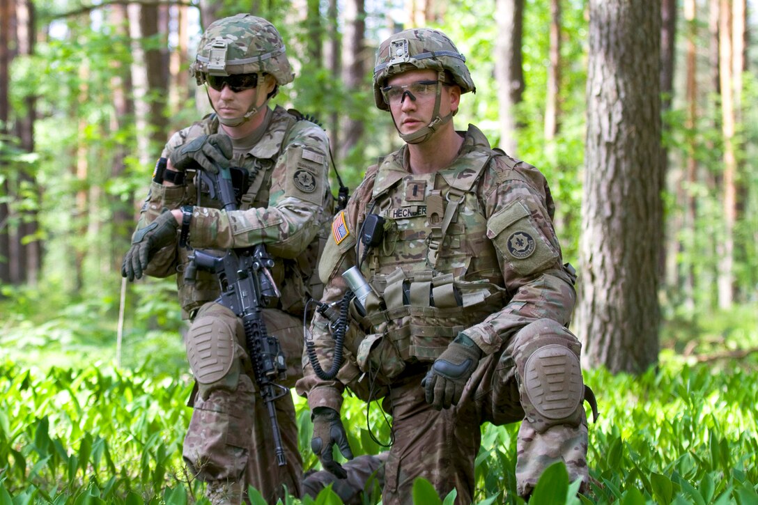 U.S. Army Capt. Bryan E. Adam, left, and 1st Lt. Bryce Heckber rest ...