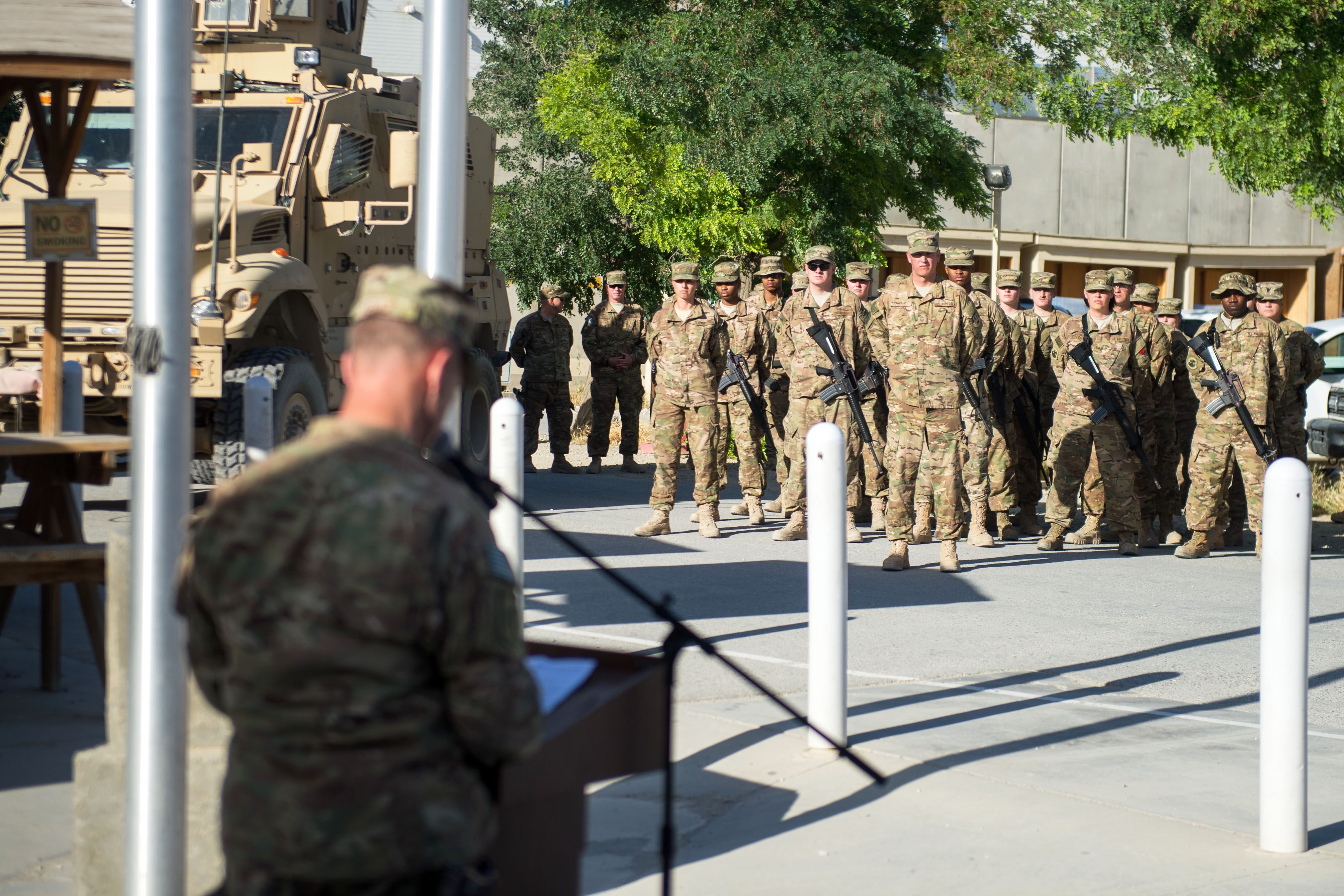 U.S. service members listen as U.S. Air Force Brig. Gen. Mark D. Kelly ...