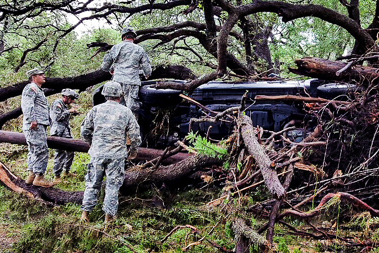 National Guard members and Texas Task Force 1 personnel search through ...