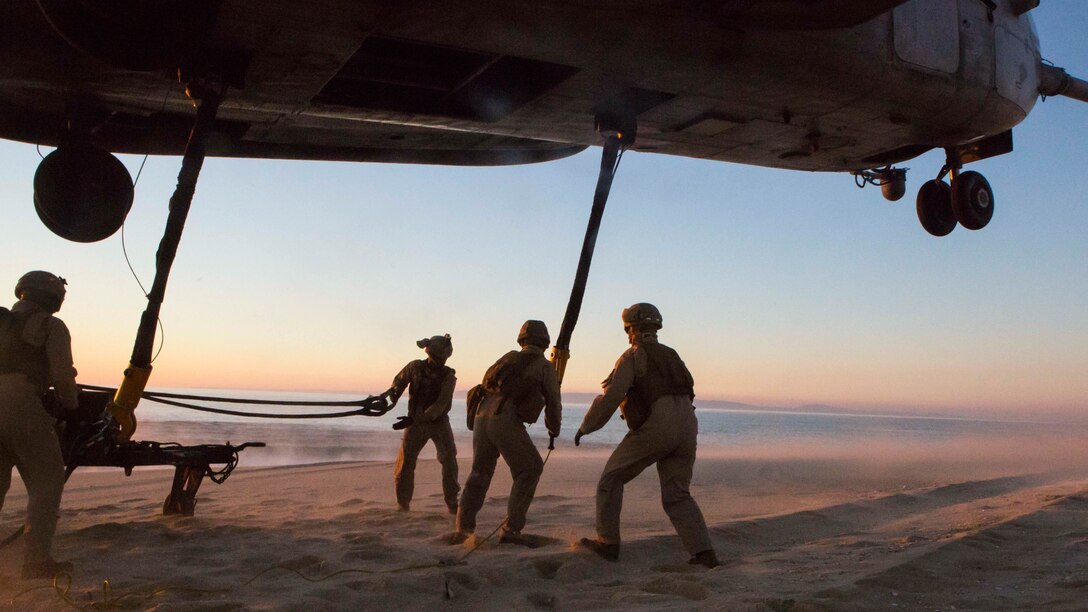 Marines with the 26th MEU perform lift at sunset on the beach