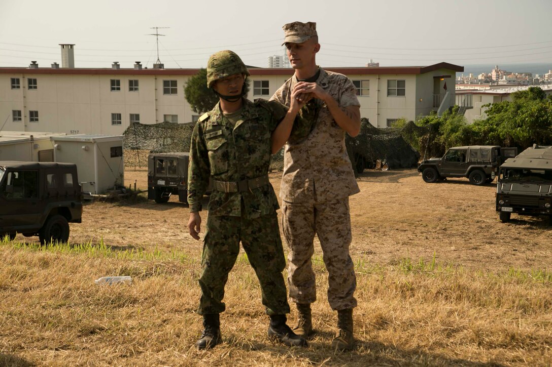 Building bonds, sharing knowledge: JGSDF learns PMO's law enforcement ...
