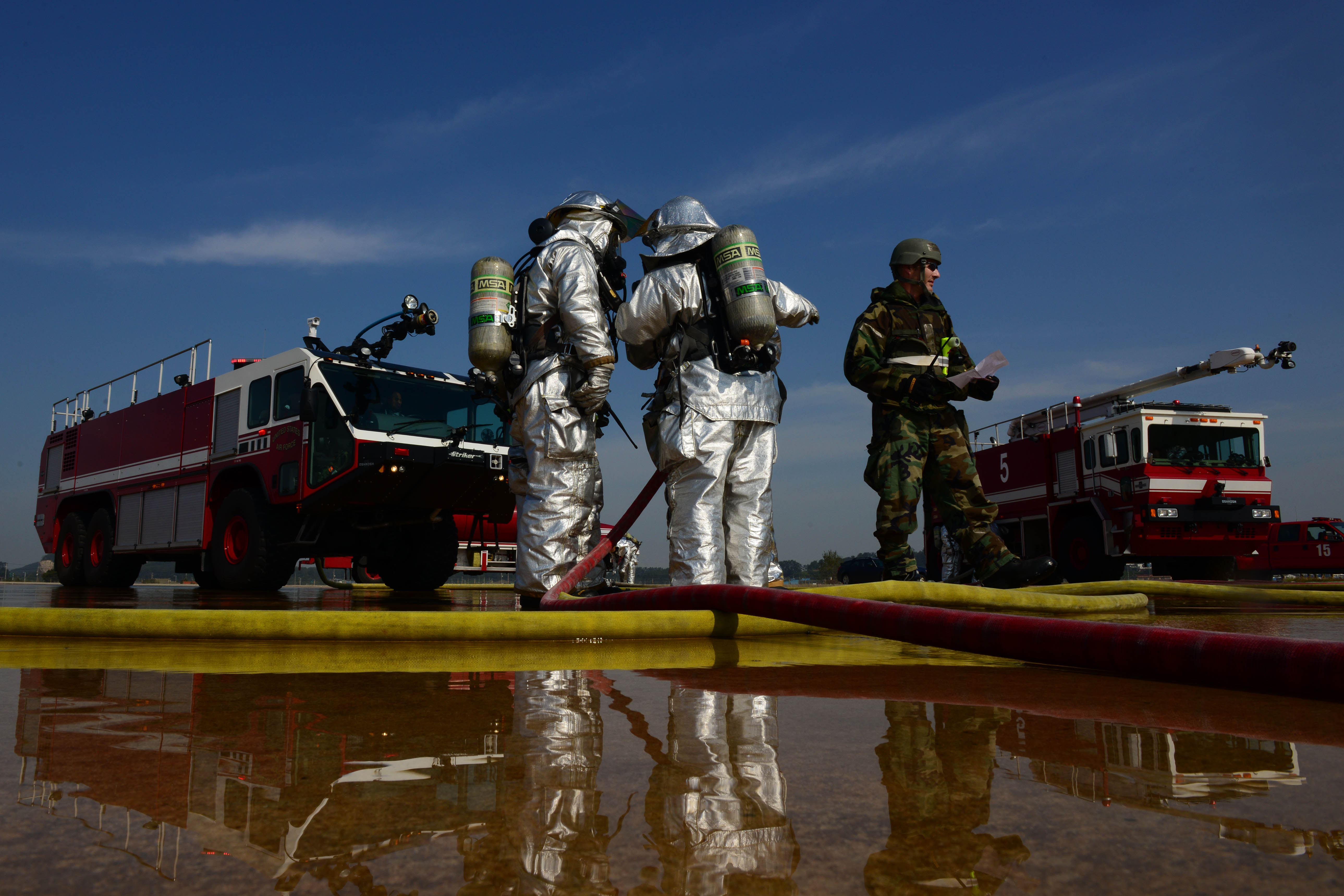 Firefighters from the 8th Civil Engineer Squadron communicate with each ...