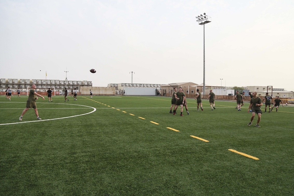 U.S. Marines play football aboard Camp Lemonnier