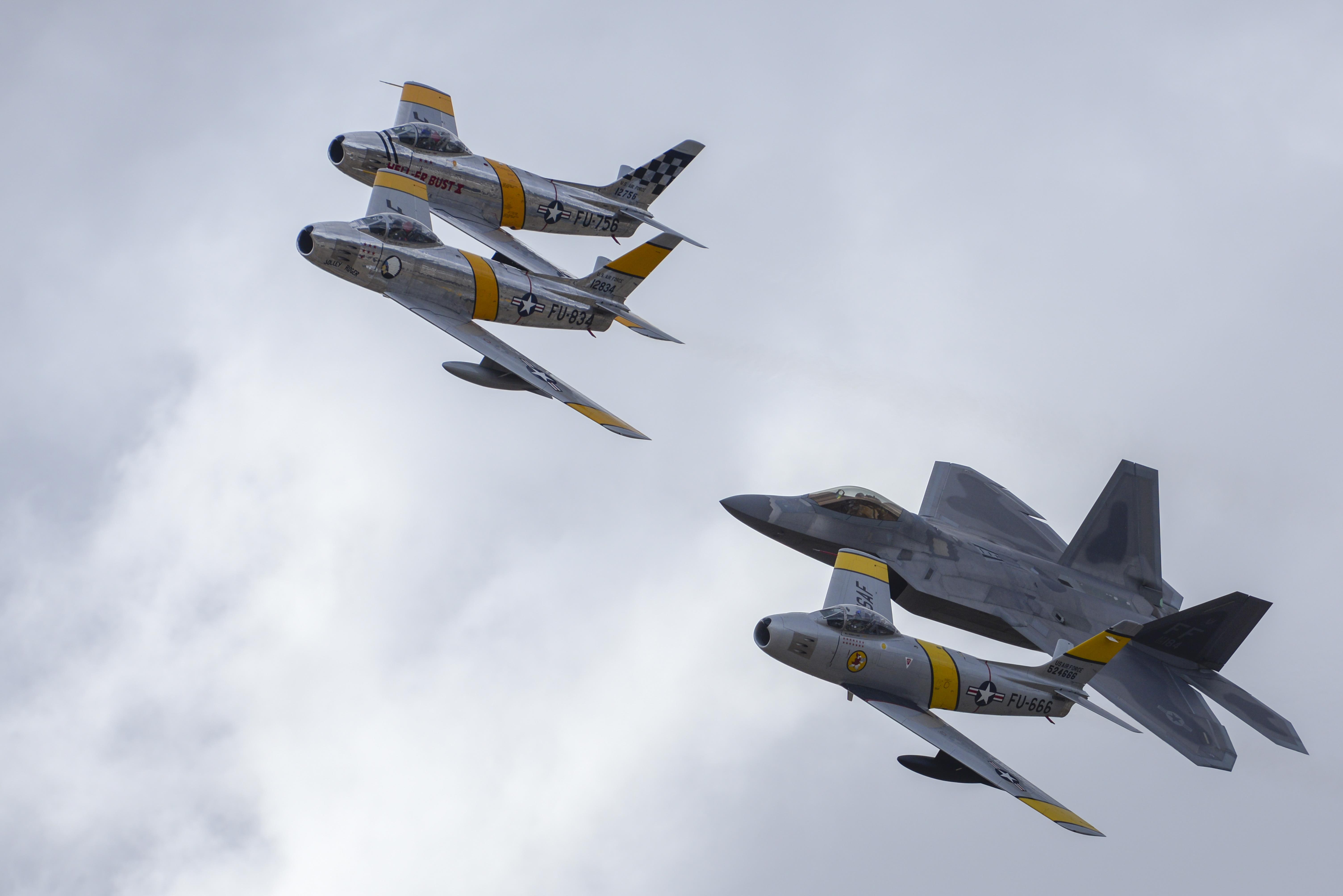"Three F-86 Sabres and an F-22 Raptor [stealth fighter jet] fly in ...