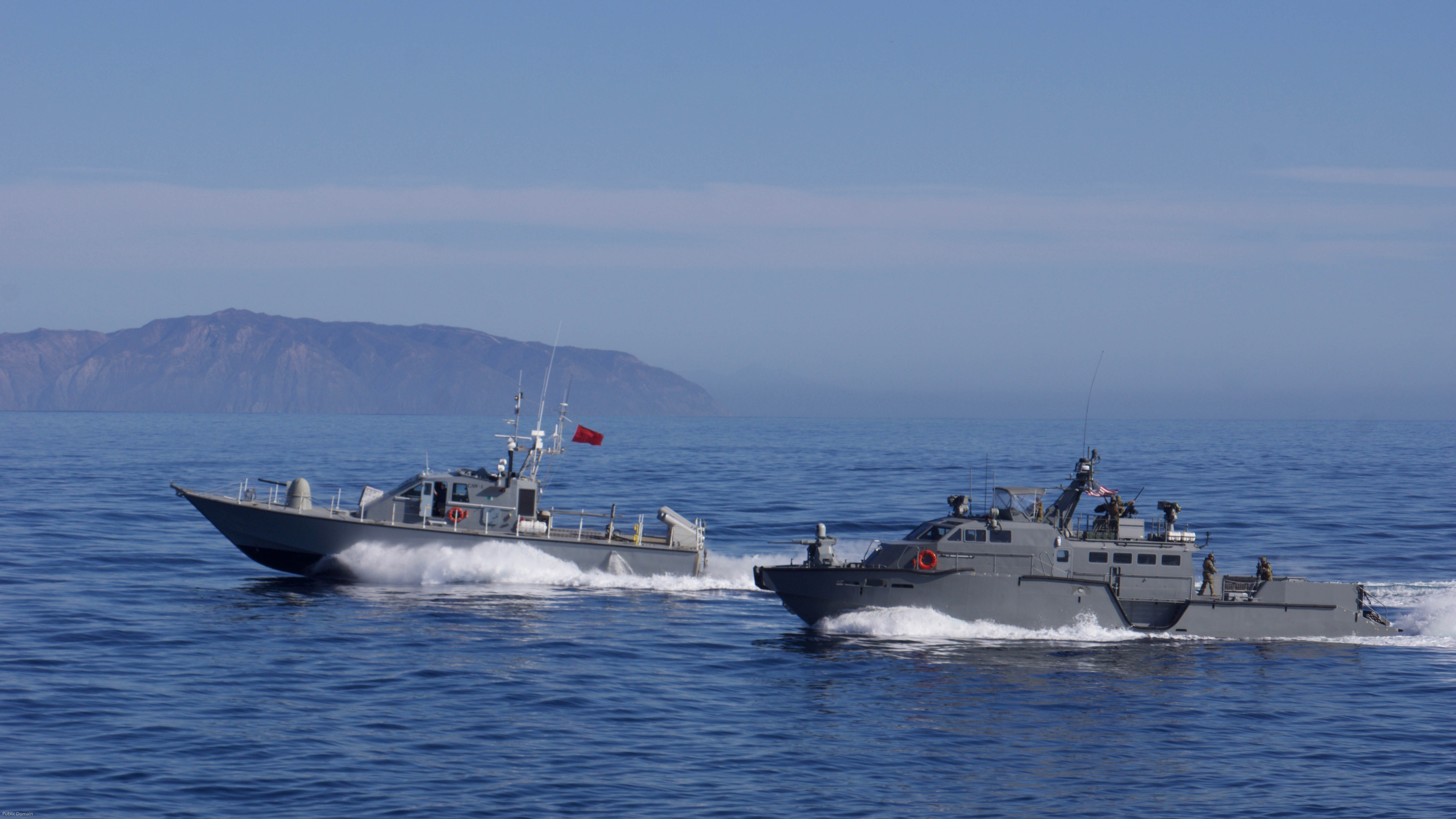 A US Navy Mark VI patrol boat wards off a Guardian Fast Patrol Craft ...