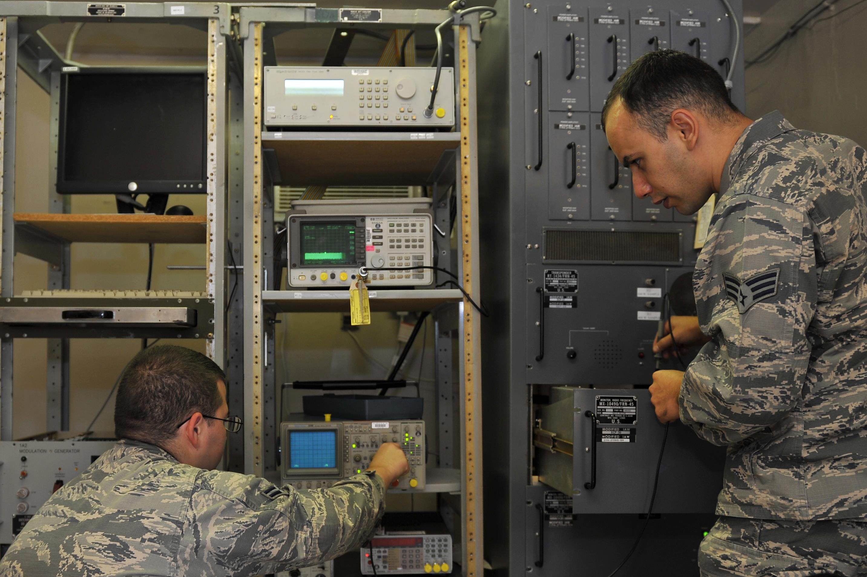 19th OSS airfield systems technicians climb radio tower