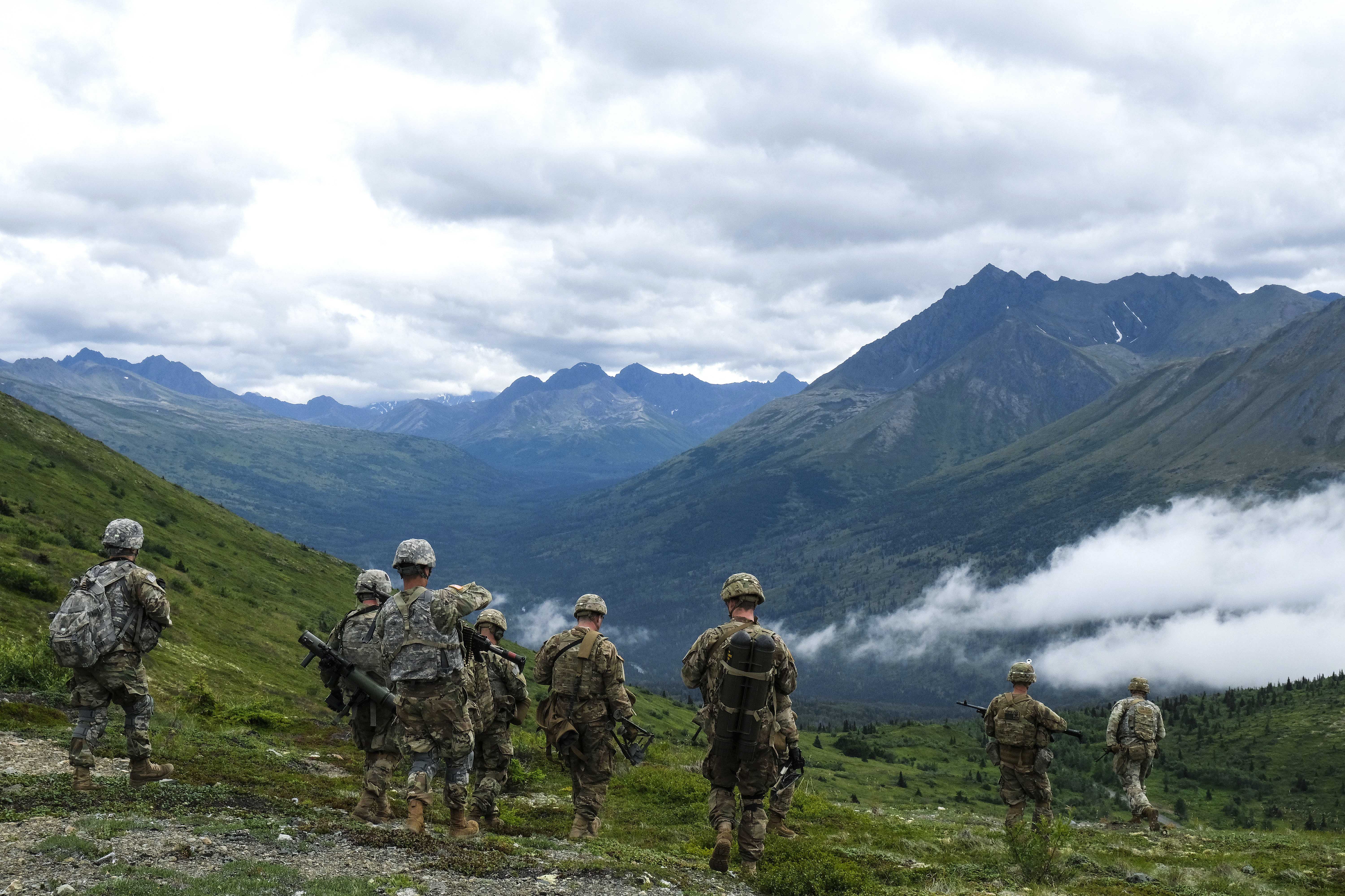 Soldiers move downhill toward their targets during a live-fire exercise ...