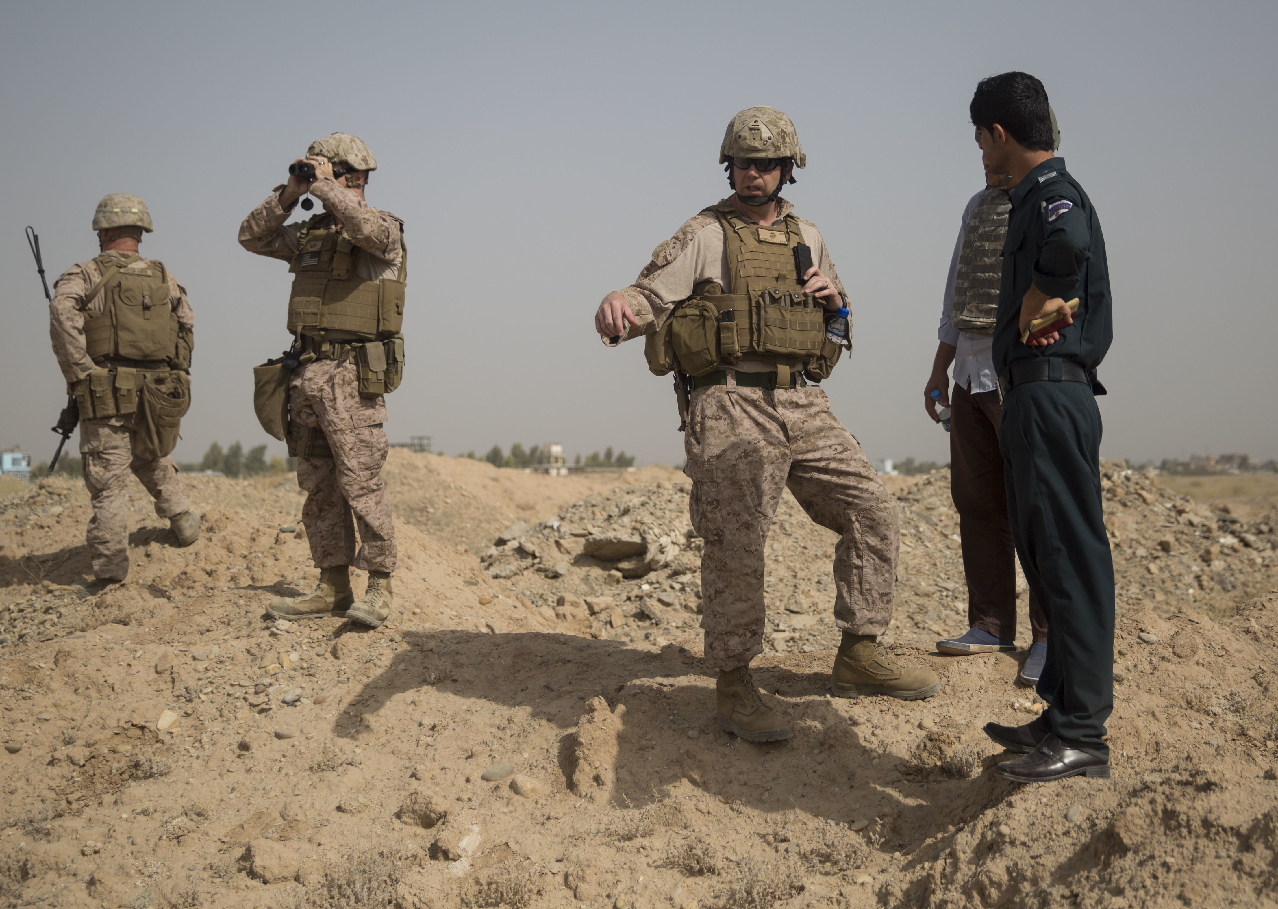 Clear the Area: U.S. Marine advisors survey for explosive demolition pit